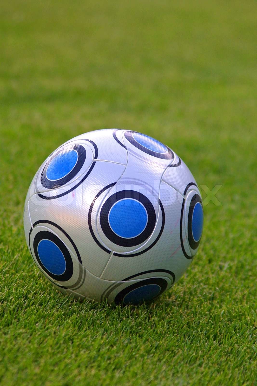 Close-up soccer ball on the green field, vertical | Stock image | Colourbox