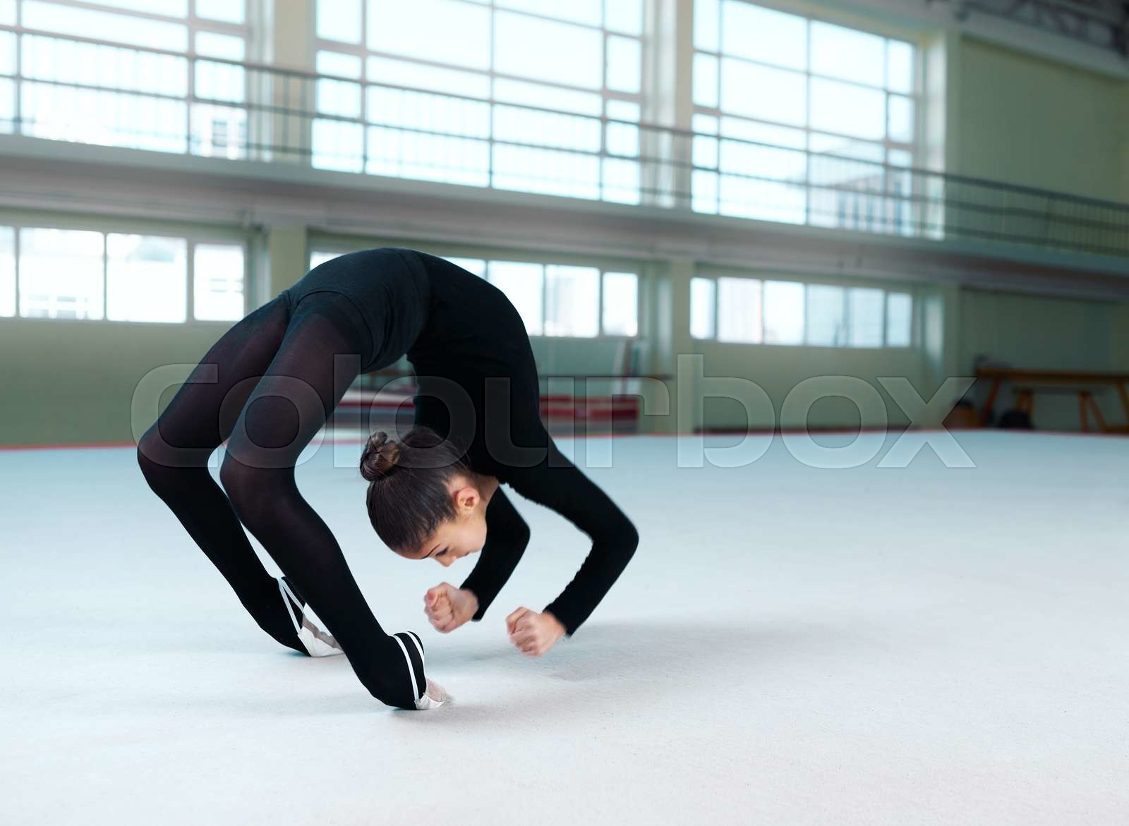 gymnast in black suit making a somersault | Stock image | Colourbox