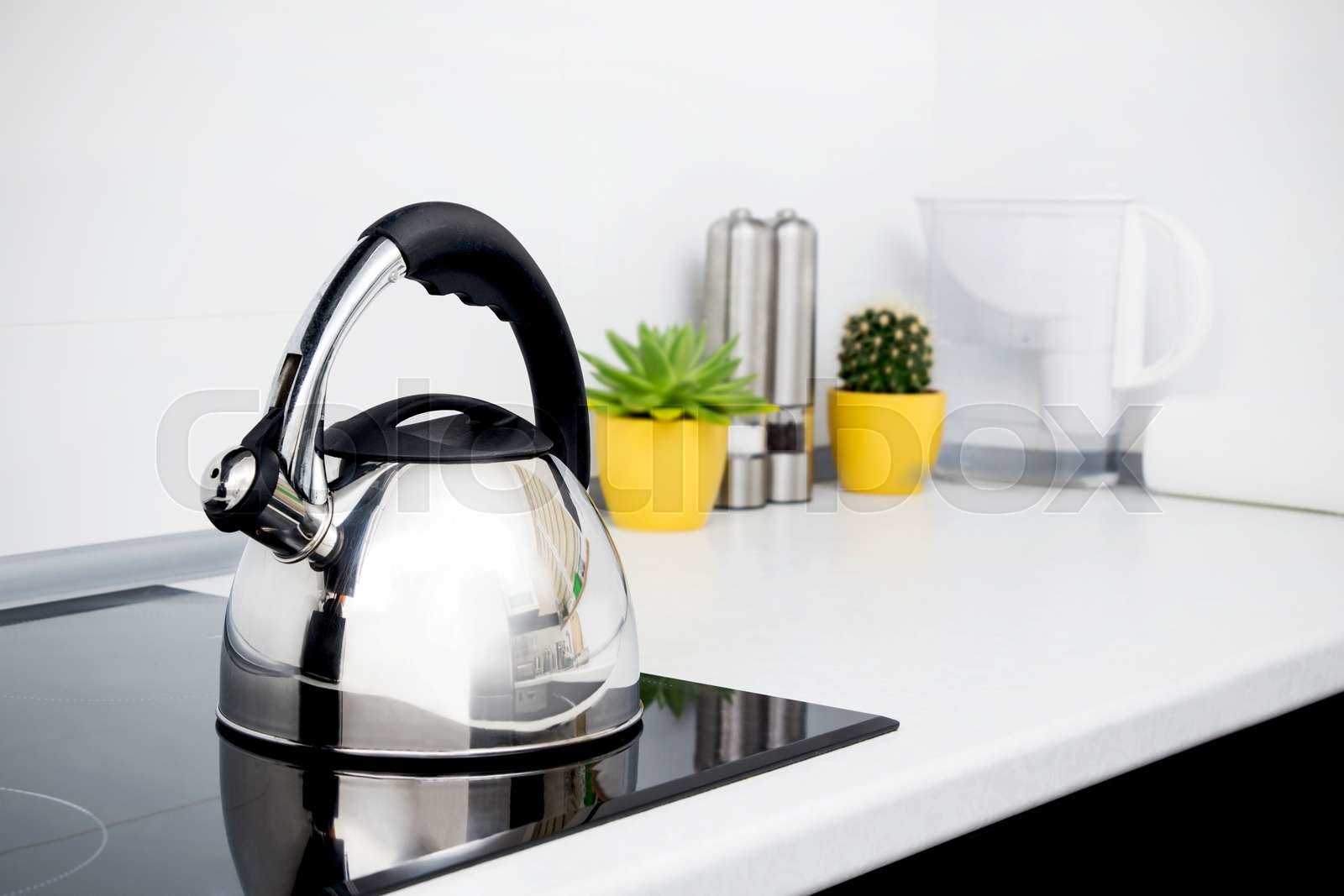 Steel kettle in modern kitchen with induction stove | Stock image ...