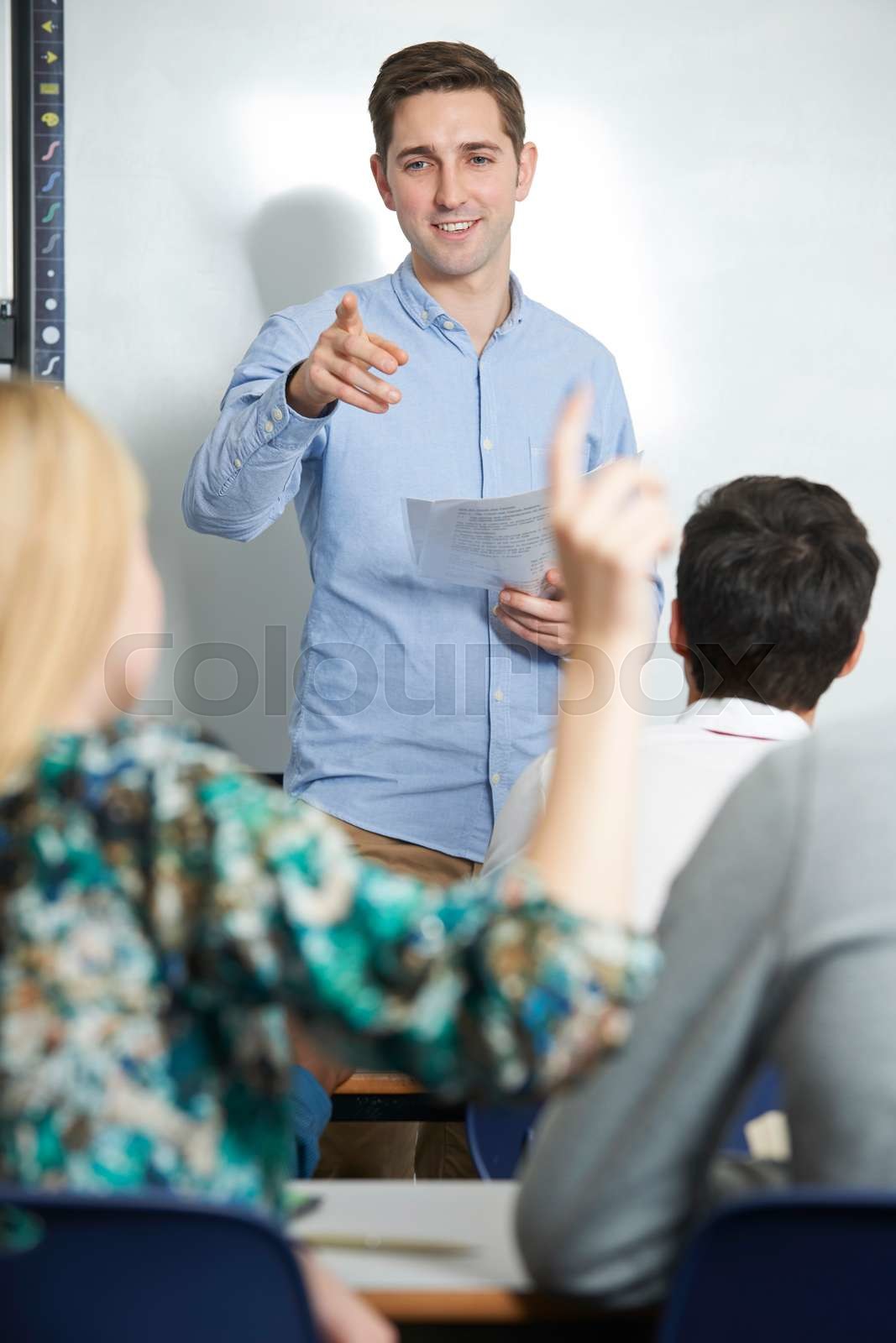 Teacher Answering Pupils Question In Classroom | Stock image | Colourbox