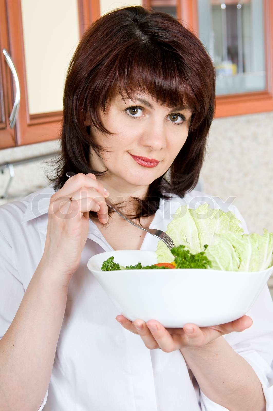 Beautiful a woman to taste cooked the food | Stock image | Colourbox
