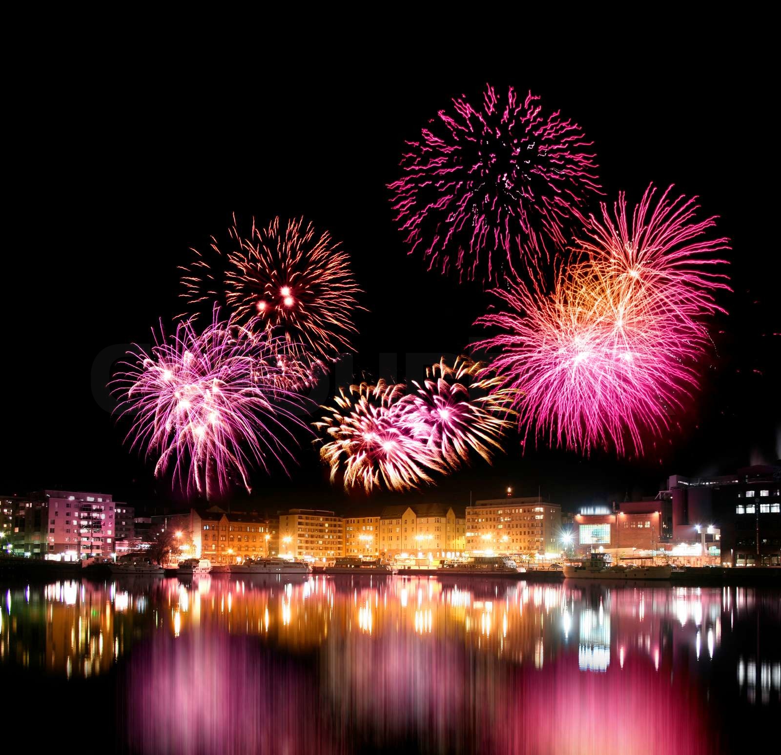 Fireworks night over city with calm water reflection | Stock image ...