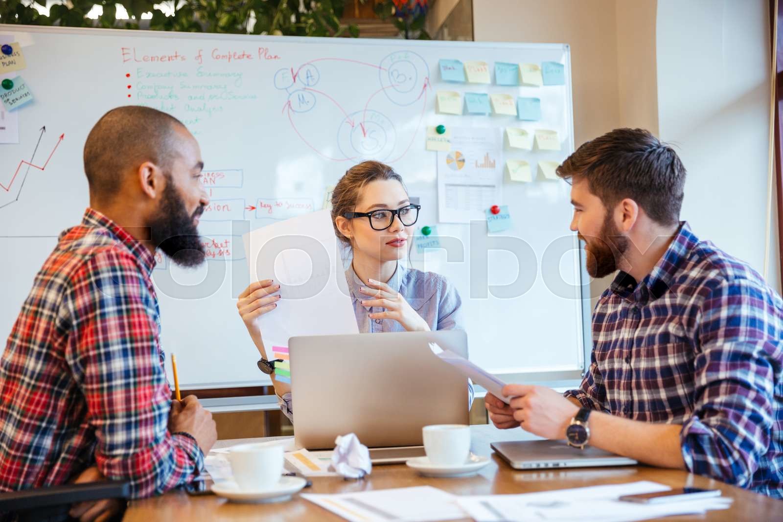 Business people preparing for presentation together | Stock image ...