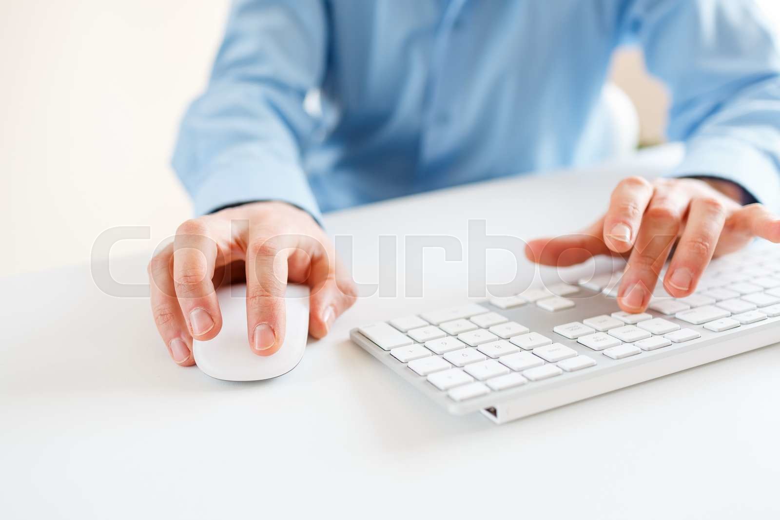 Men office worker typing on the keyboard | Stock image | Colourbox