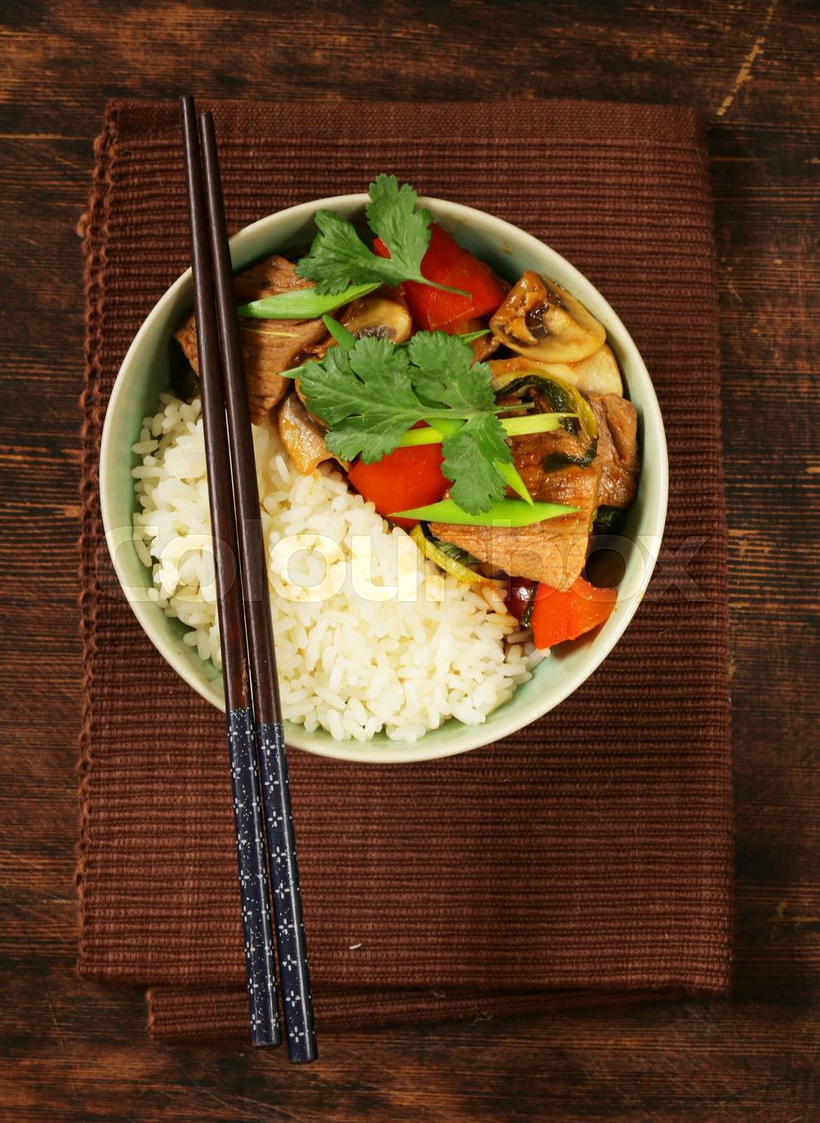 Traditional Asian food - white rice and meat with vegetables in soy ...