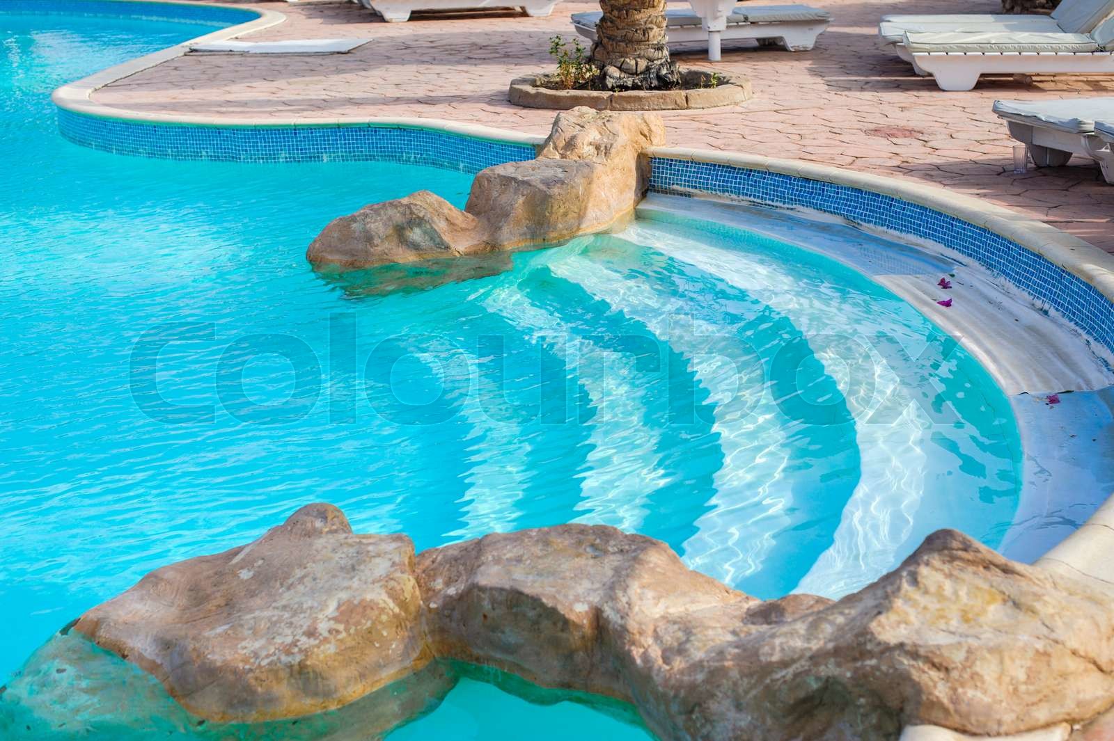 Corner of a swimming pool with decorative stones | Stock image | Colourbox