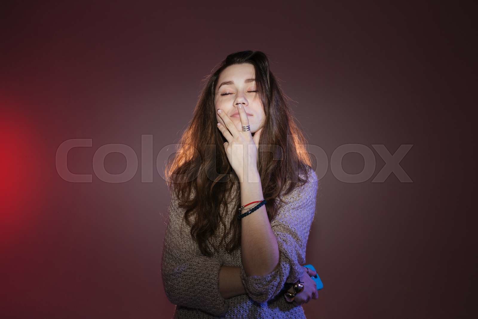 Drug addicted woman standing with eyes closed | Stock image | Colourbox
