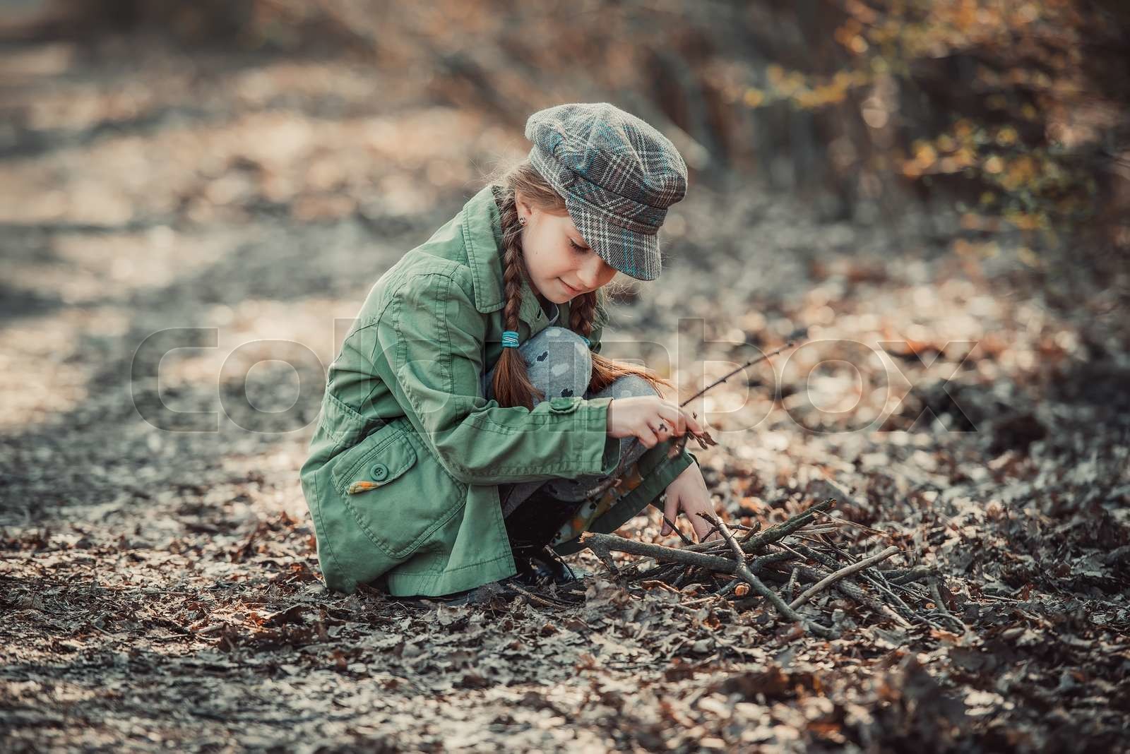 little girl making a bonfire | Stock image | Colourbox