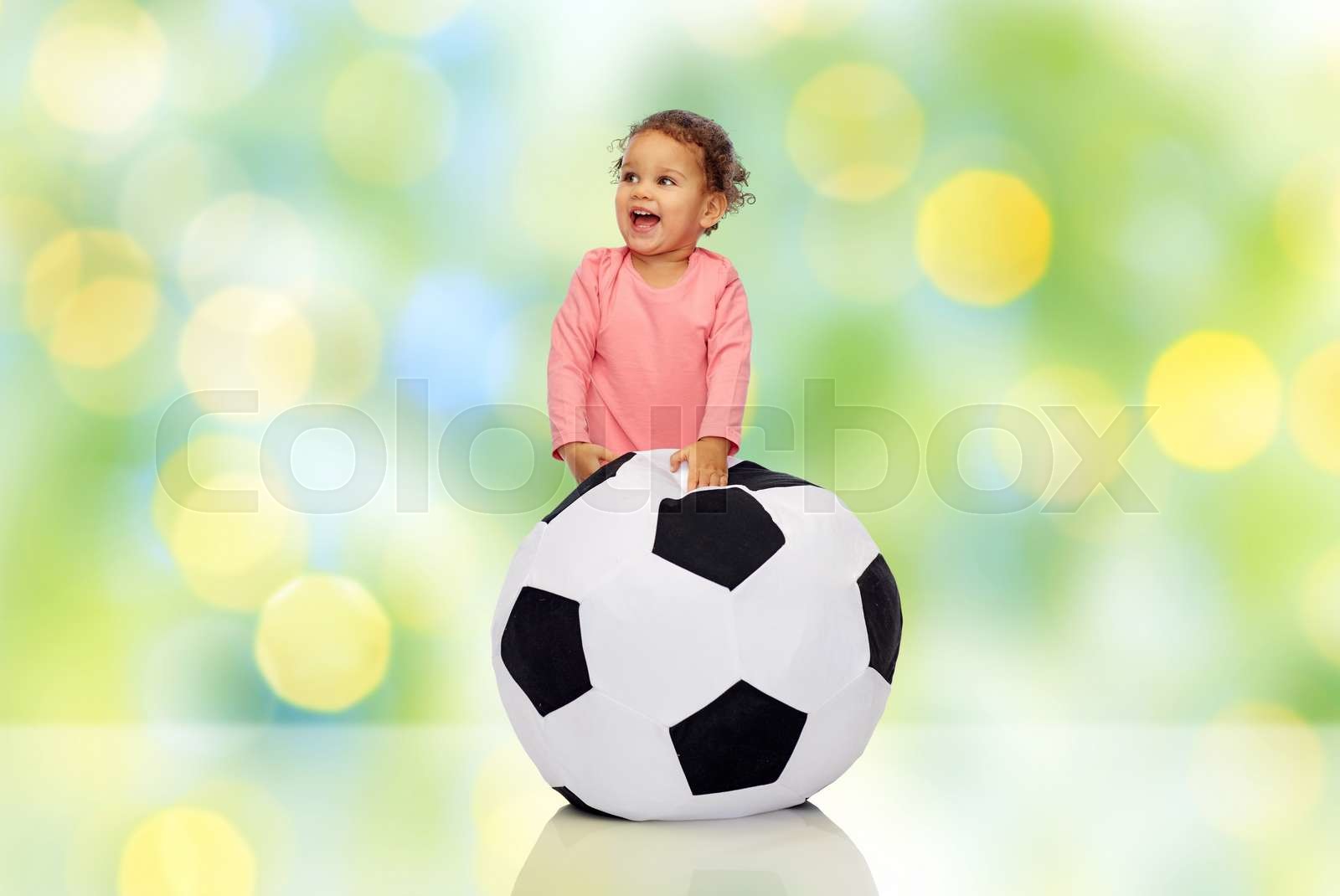happy mulatto little baby girl playing with ball | Stock image | Colourbox