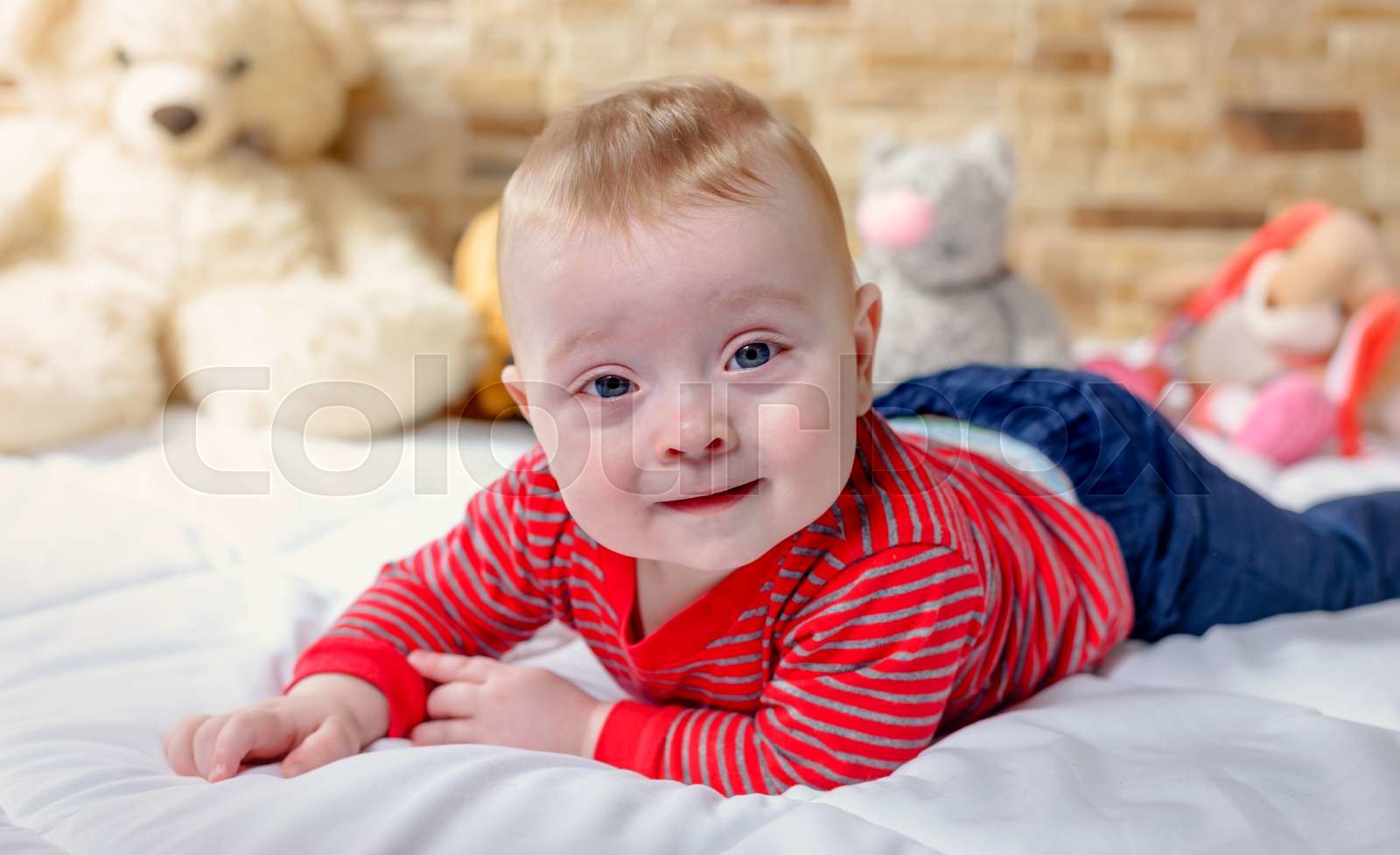 Cute chubby little baby with a happy smile | Stock image | Colourbox
