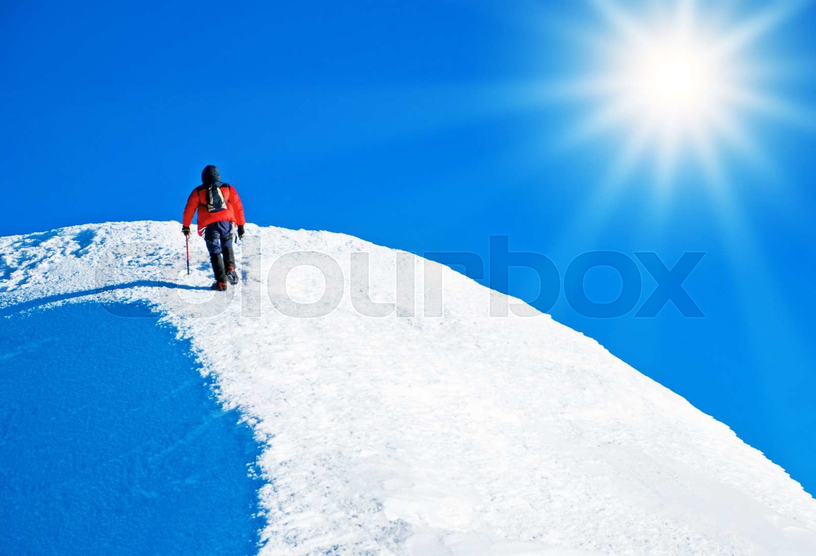 A climber reaching the summit | Stock image | Colourbox