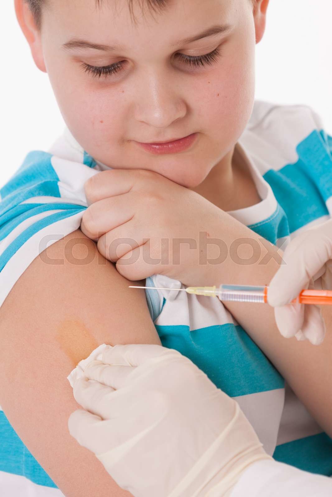Doctor giving a child injection in arm on isolated image. | Stock image ...