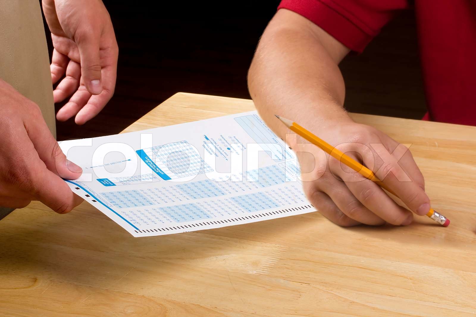 Teacher handing a test to a student with a pencil. | Stock image ...