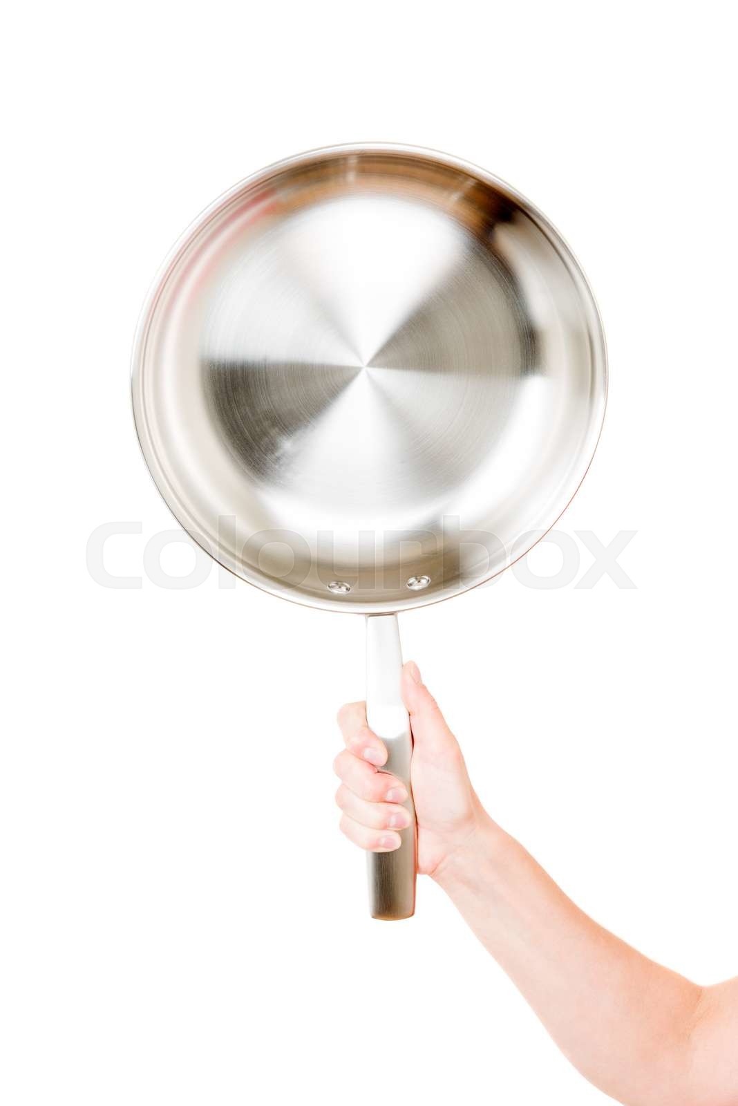 Steel frying pan hold by hand isolated on white | Stock image | Colourbox