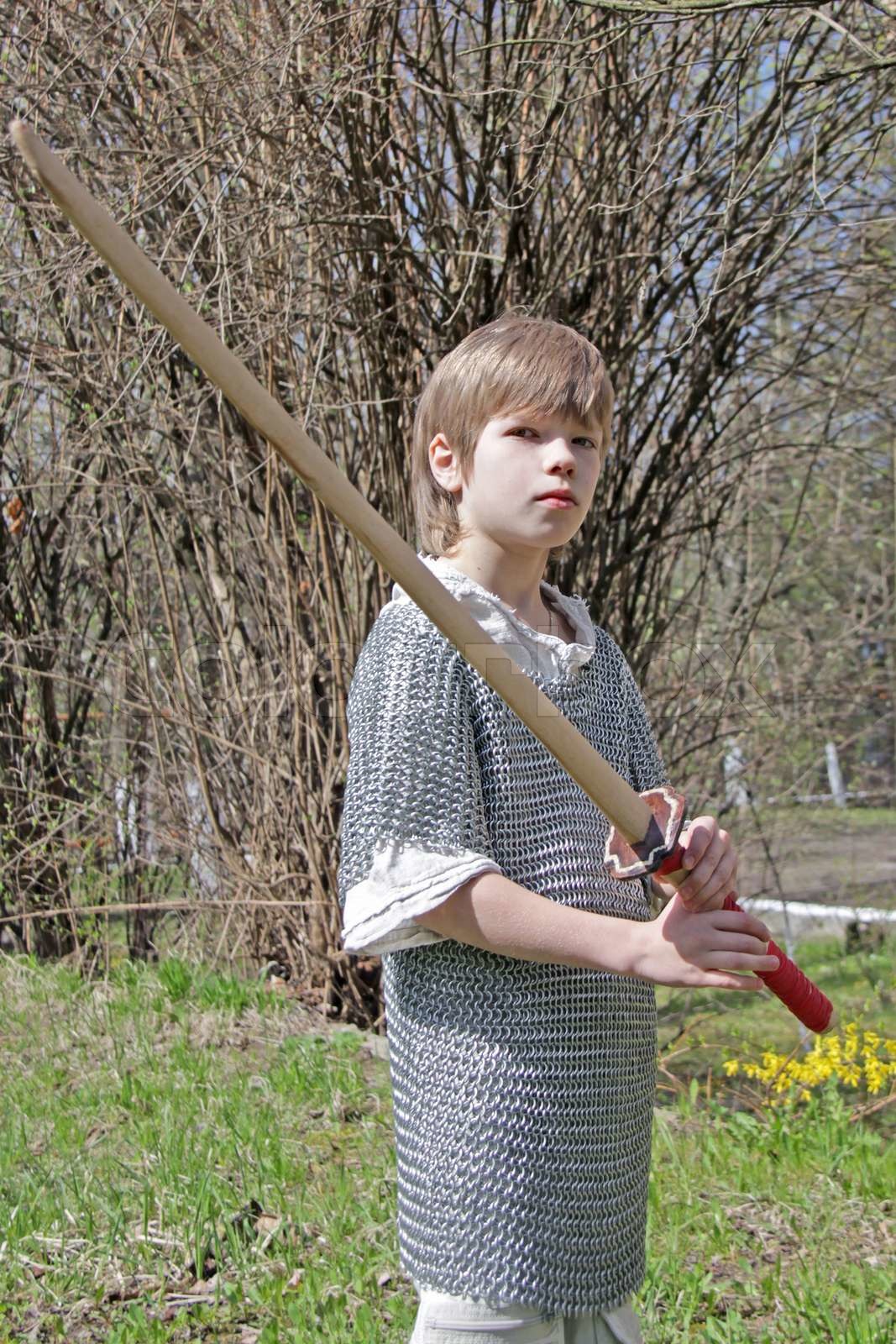 Small knight with wooden sword | Stock image | Colourbox