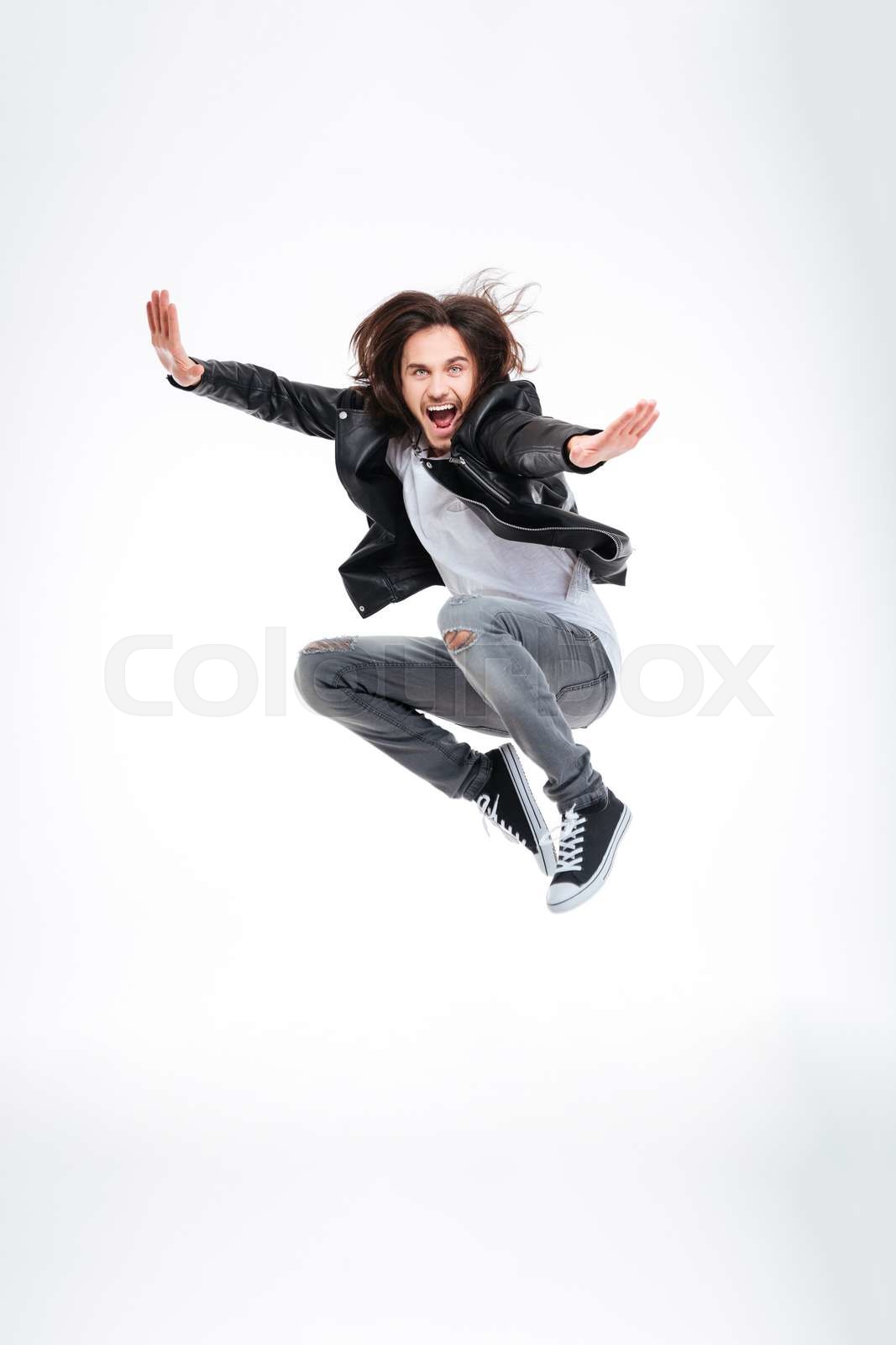 Handsome excited young man jumping and screaming | Stock image | Colourbox