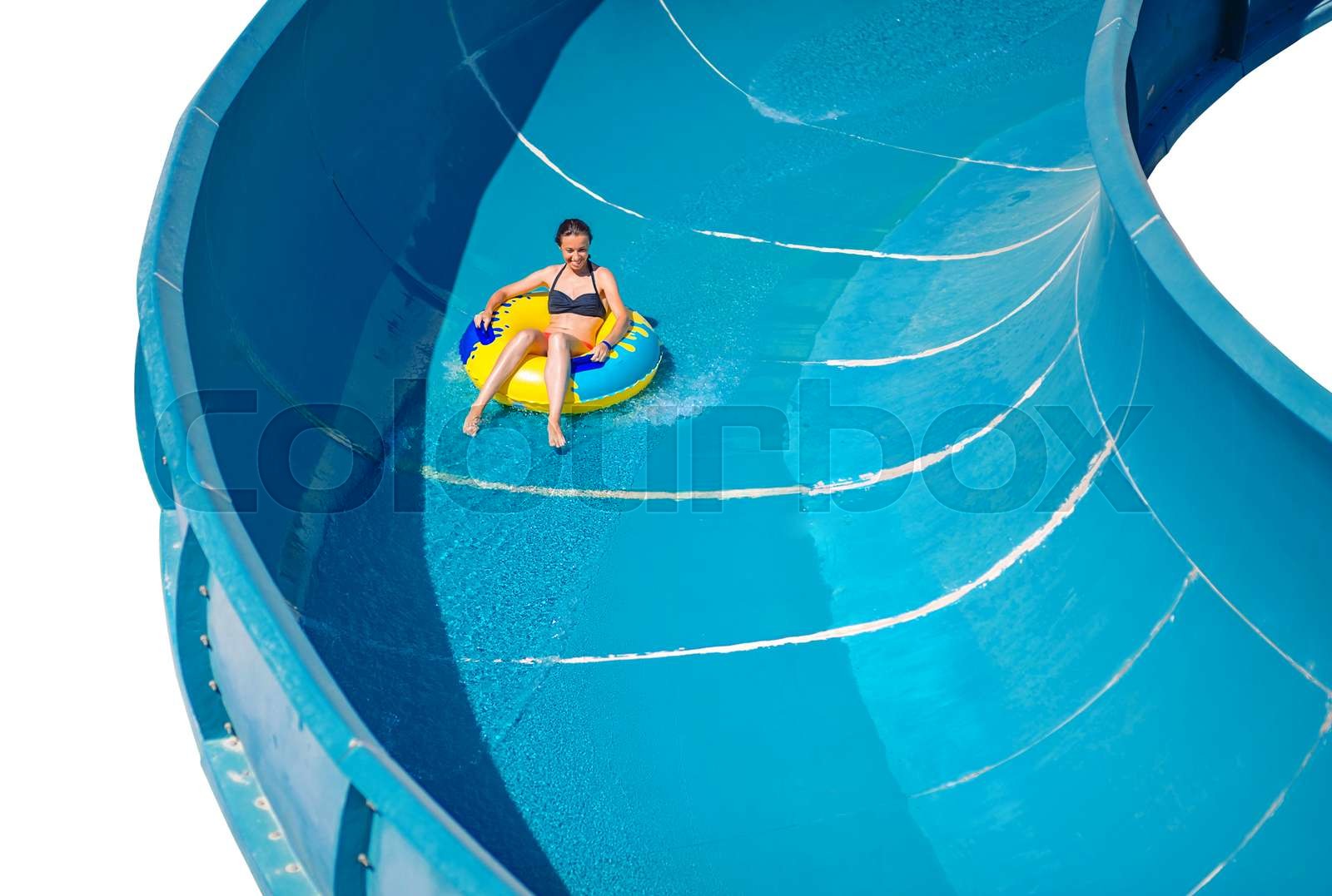 Beautiful girl riding a water slide | Stock image | Colourbox