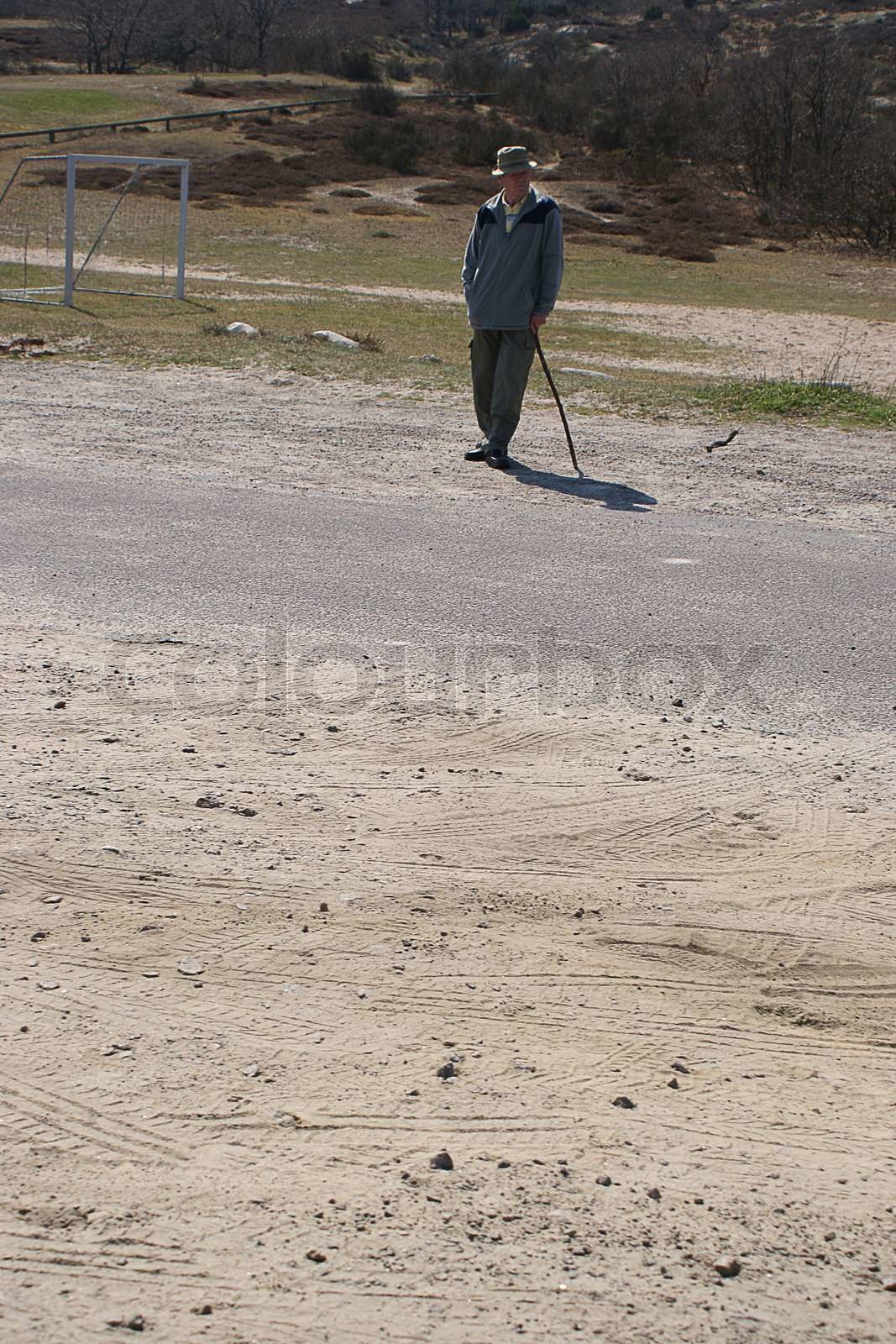 Man with stick standing. | Stock image | Colourbox