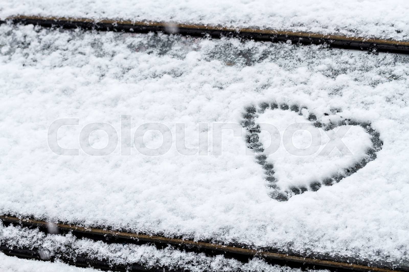 Heart symbol on a car windshield. | Stock image | Colourbox