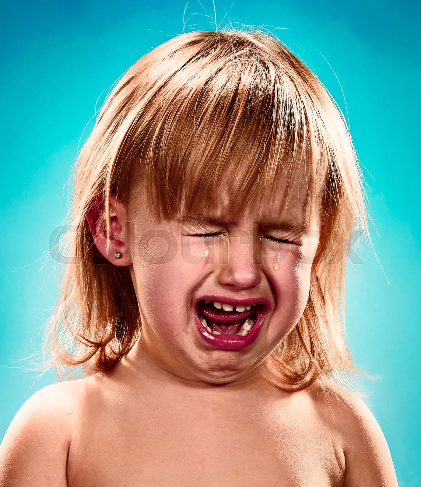 Portrait of a little girl. She is crying | Stock image | Colourbox