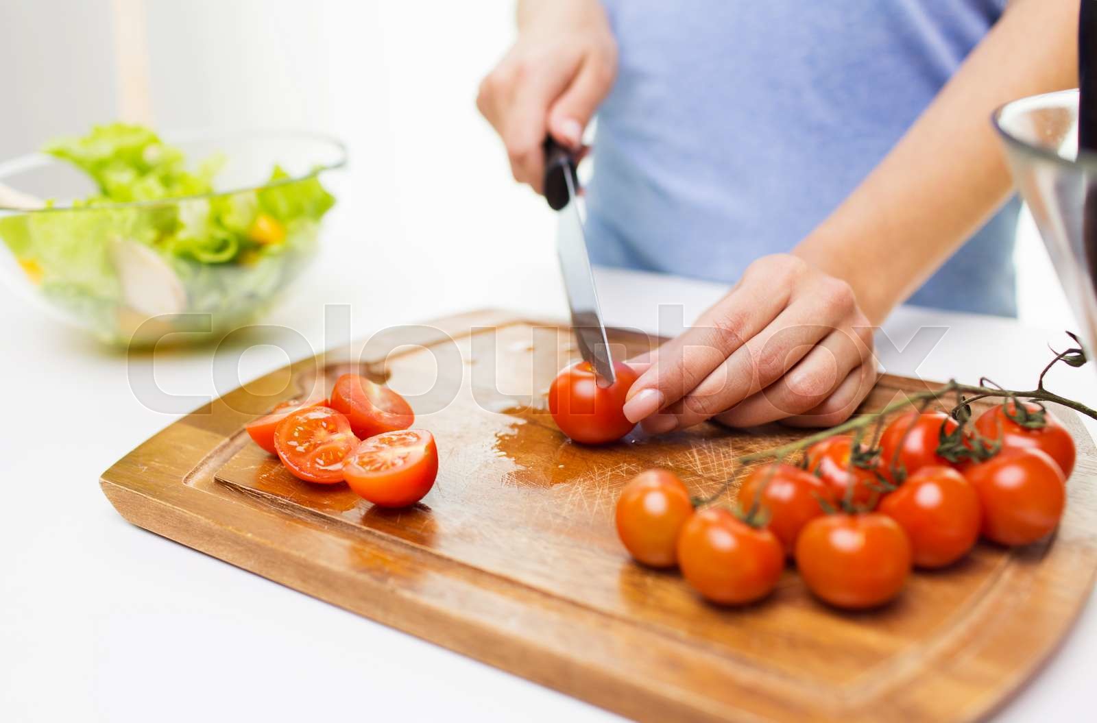 close up of woman chopping tomatoes with knife | Stock image | Colourbox