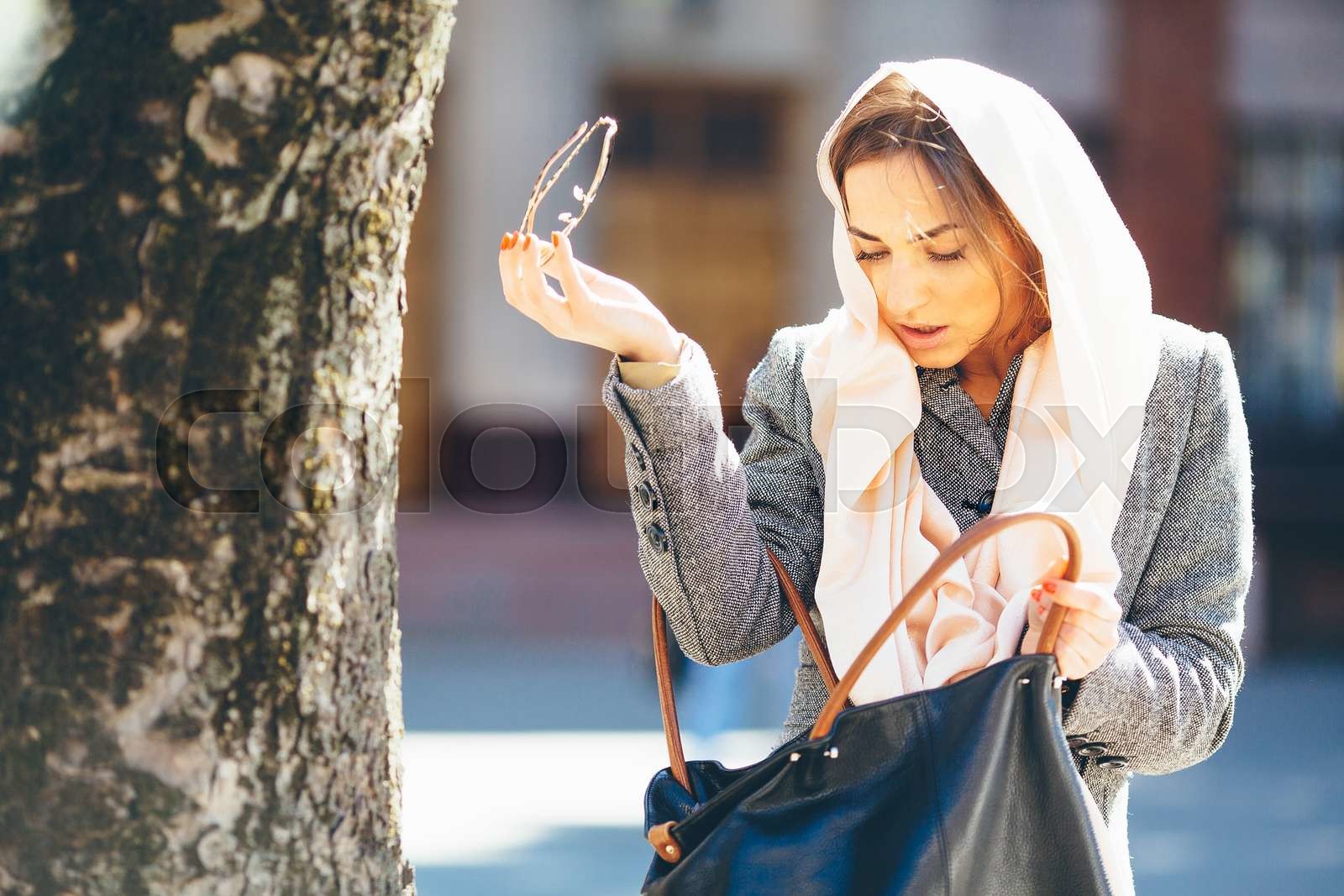 girl looking for something in a bag | Stock image | Colourbox