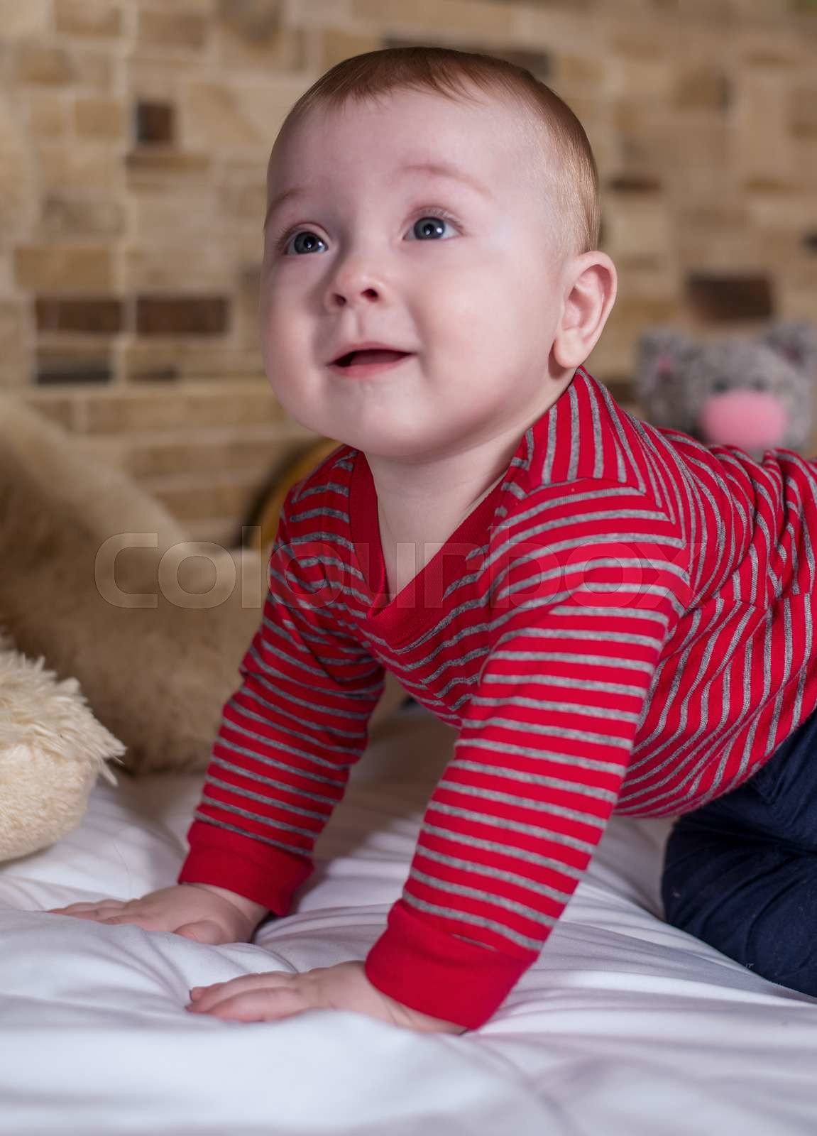 Cute chubby little baby with a happy smile | Stock image | Colourbox