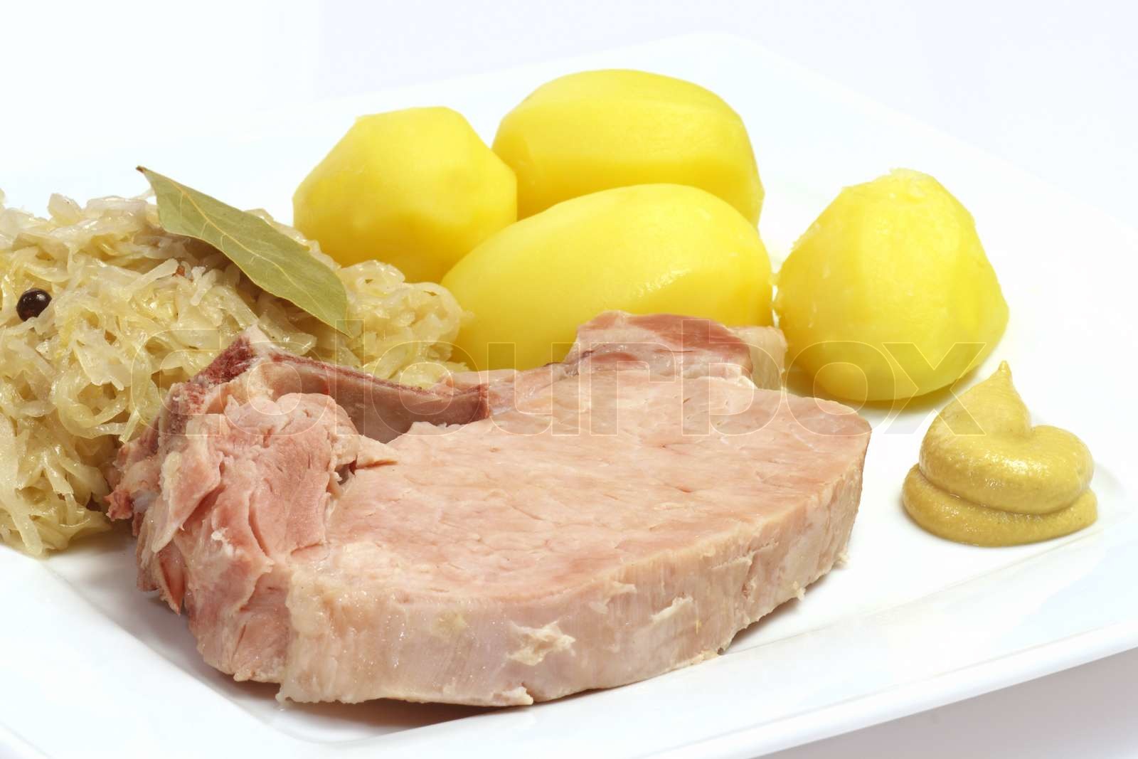 Traditional german pork meat with sauerkraut and potatoes | Stock image ...