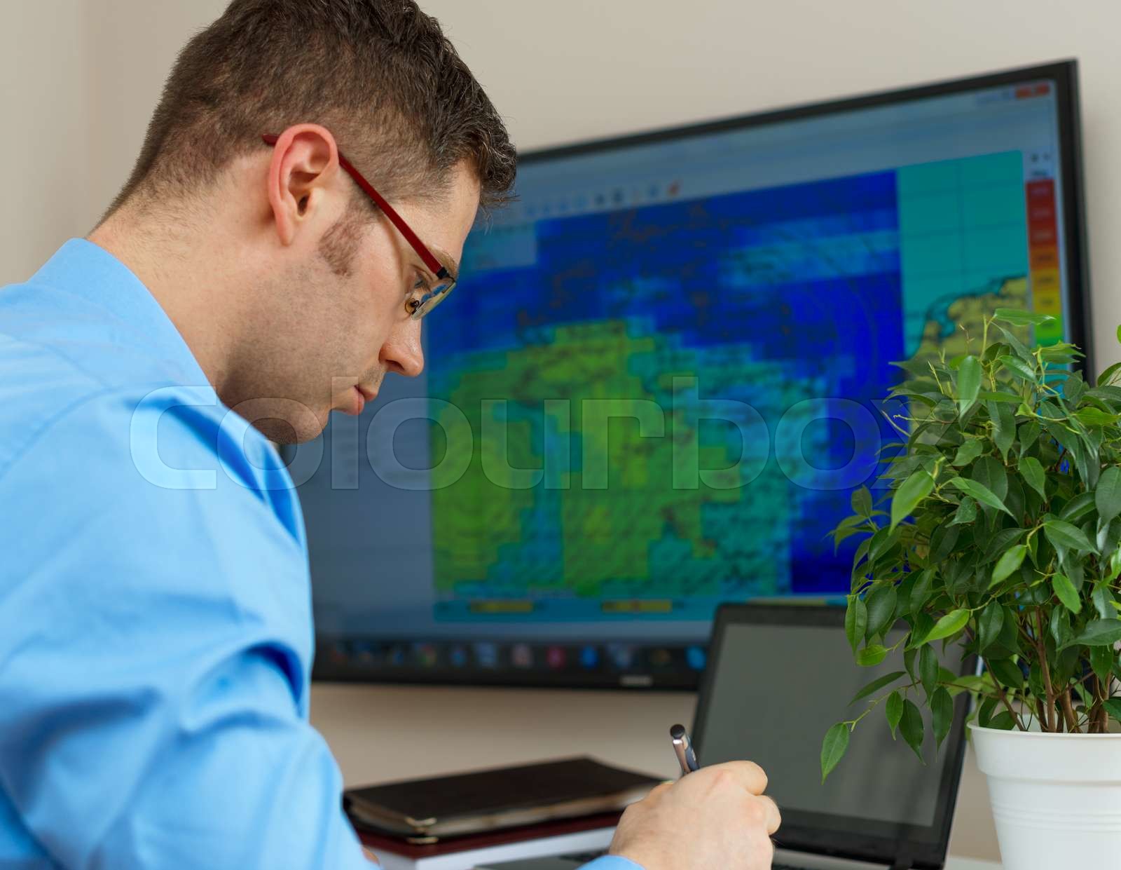 Handsome male meteorologist in glasses on his workplace. | Stock image ...