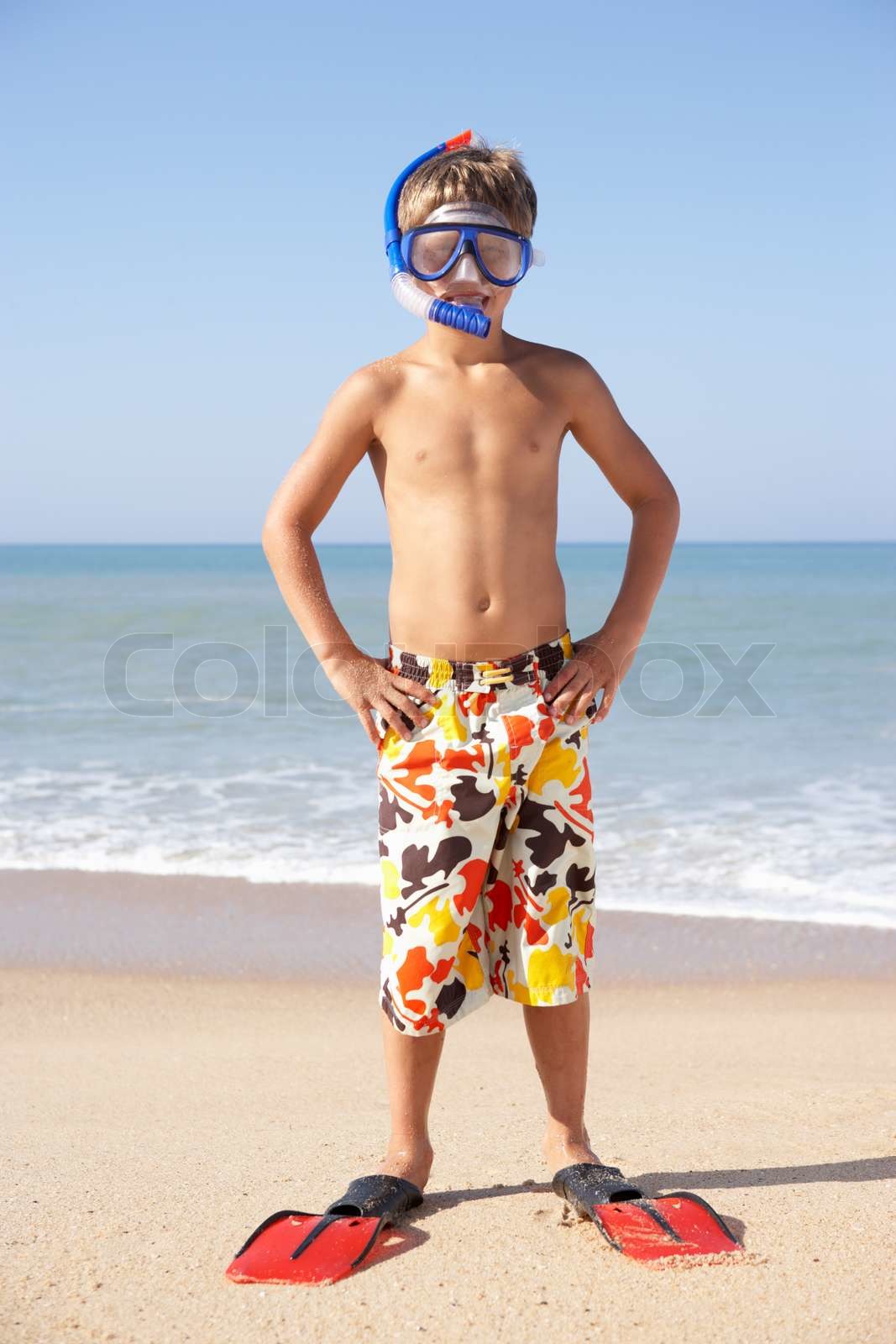 Young boy poses on beach | Stock image | Colourbox