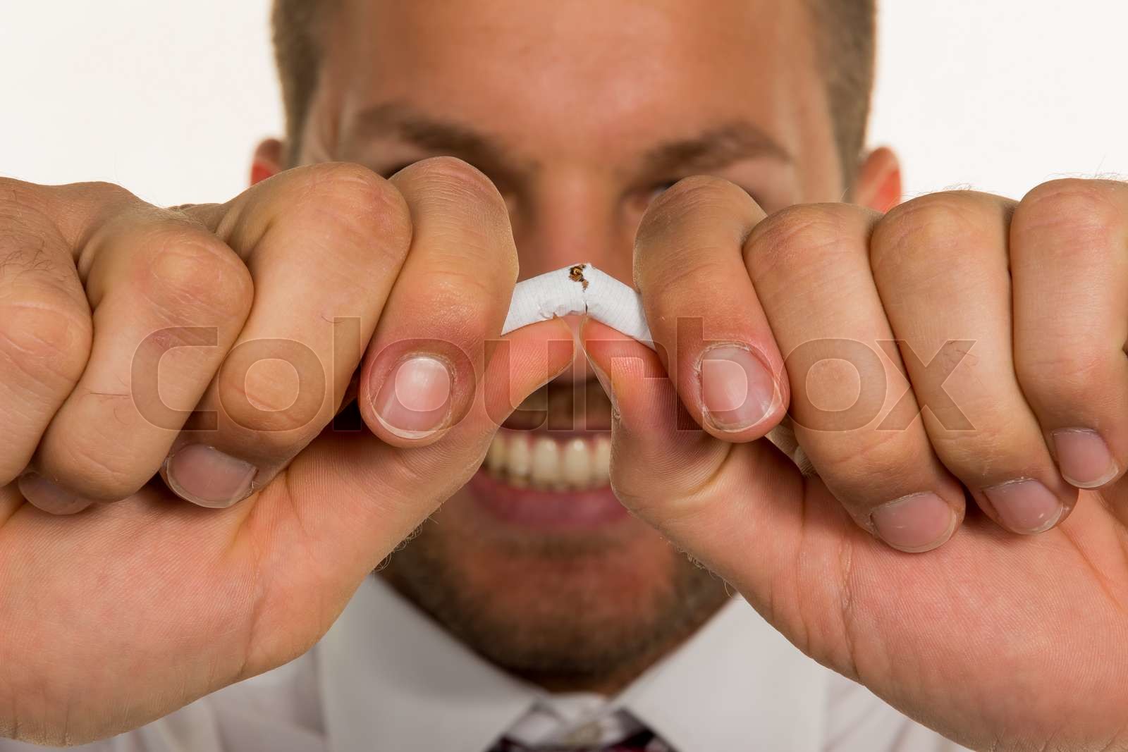 man breaks cigarette | Stock image | Colourbox