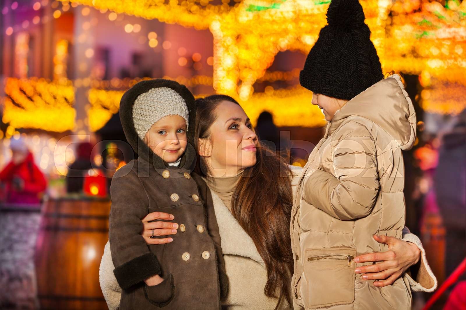 Mother hugging her two beautiful daughters | Stock image | Colourbox