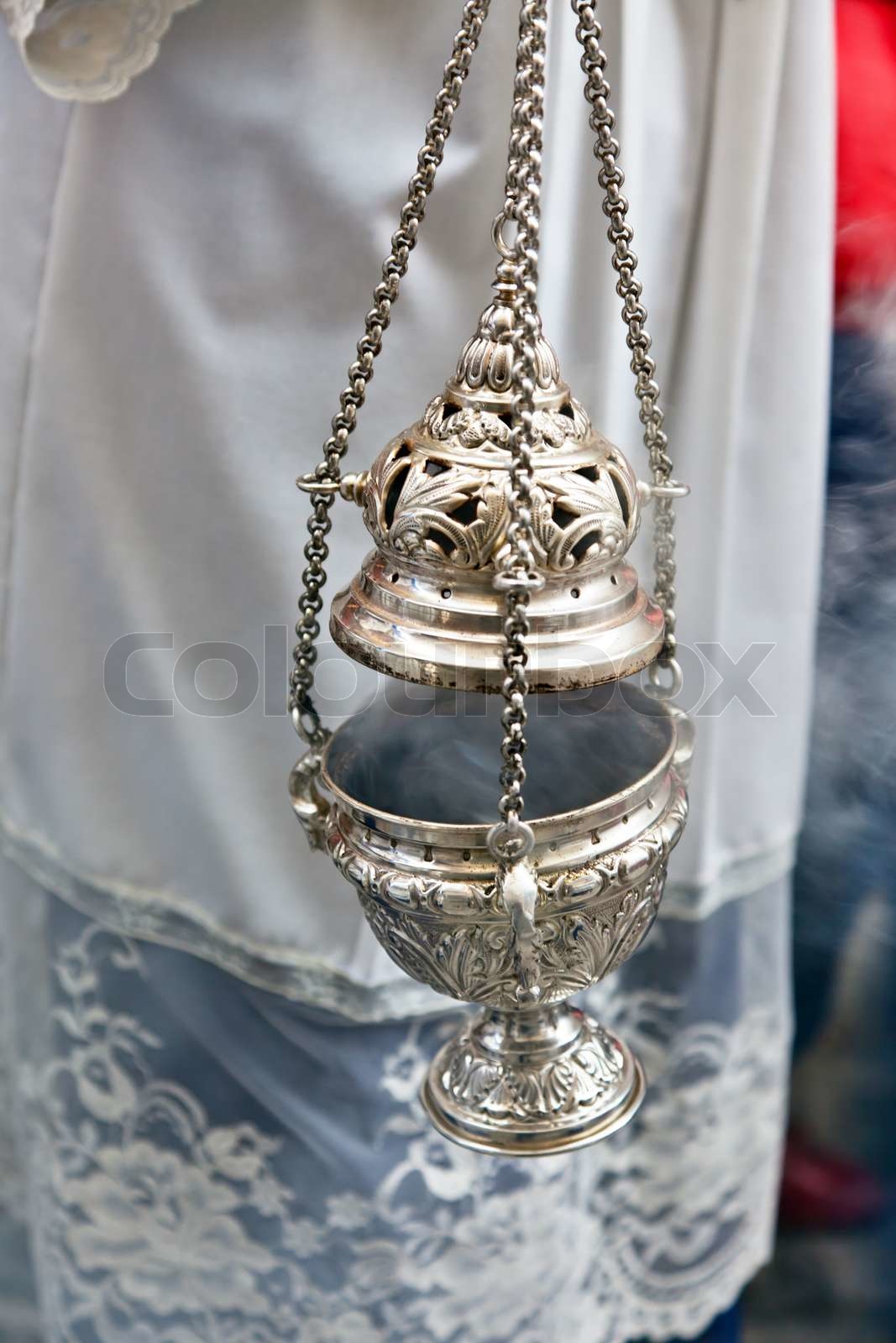 A jar full of incense in a religious procession. | Stock image | Colourbox