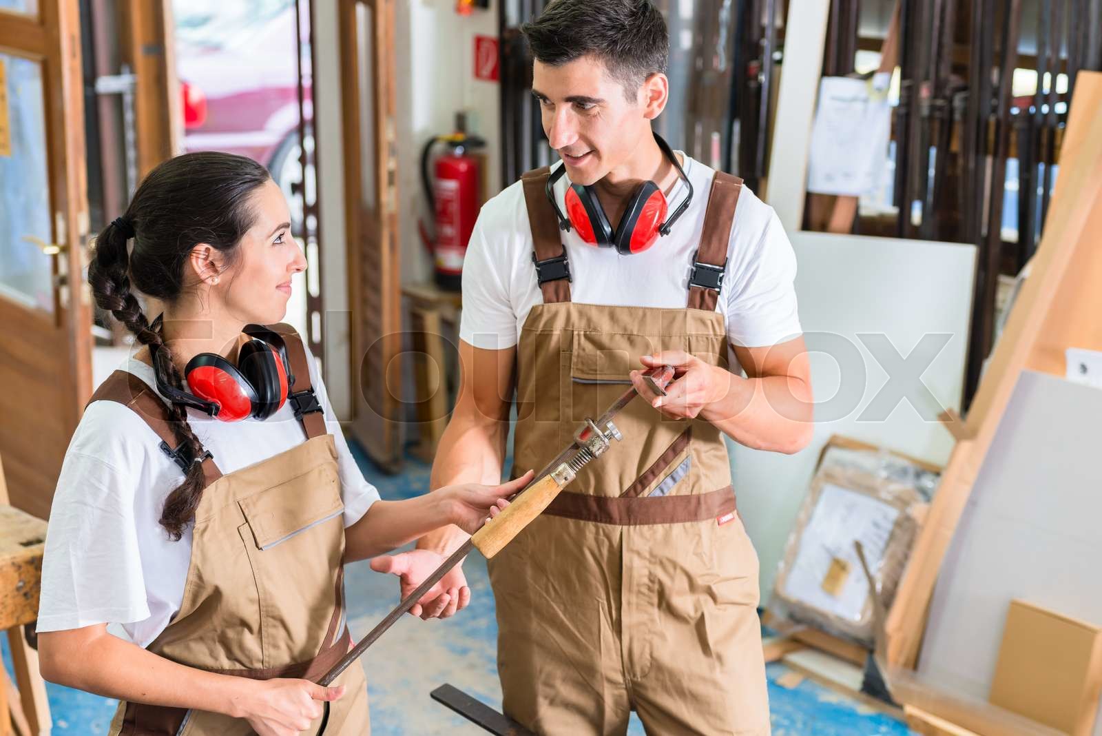 Team of carpenters comparing work pieces | Stock image | Colourbox
