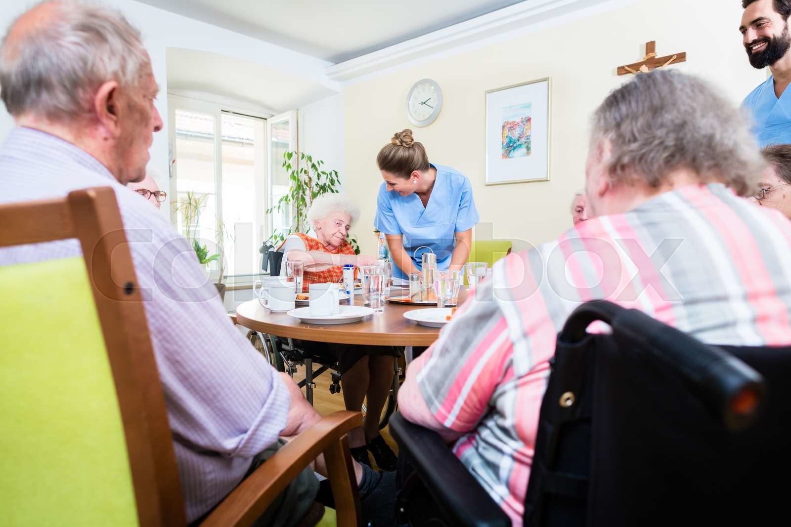 Group of seniors having food in nursing home | Stock image | Colourbox
