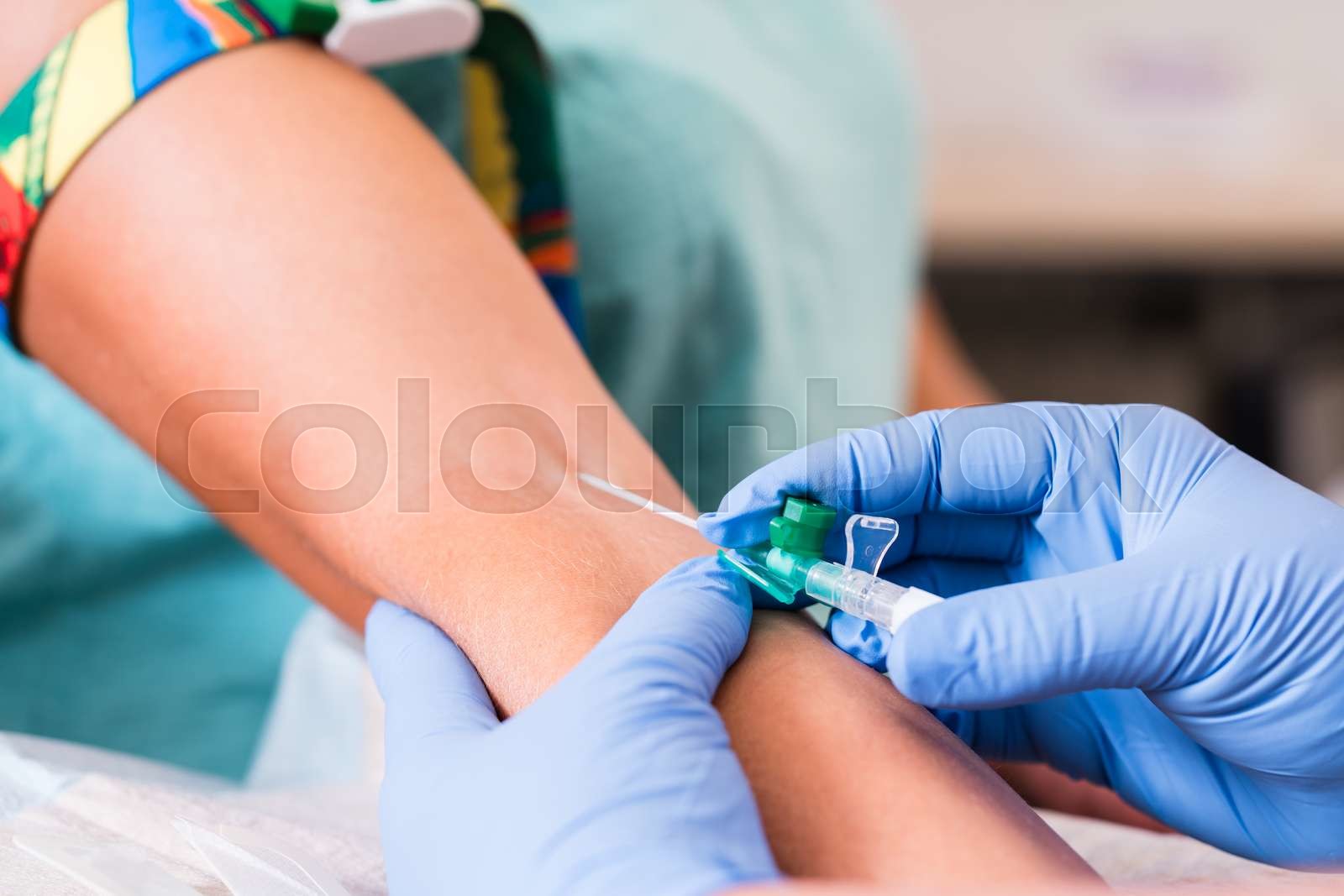 Physician or nurse taking blood sample of woman | Stock image | Colourbox