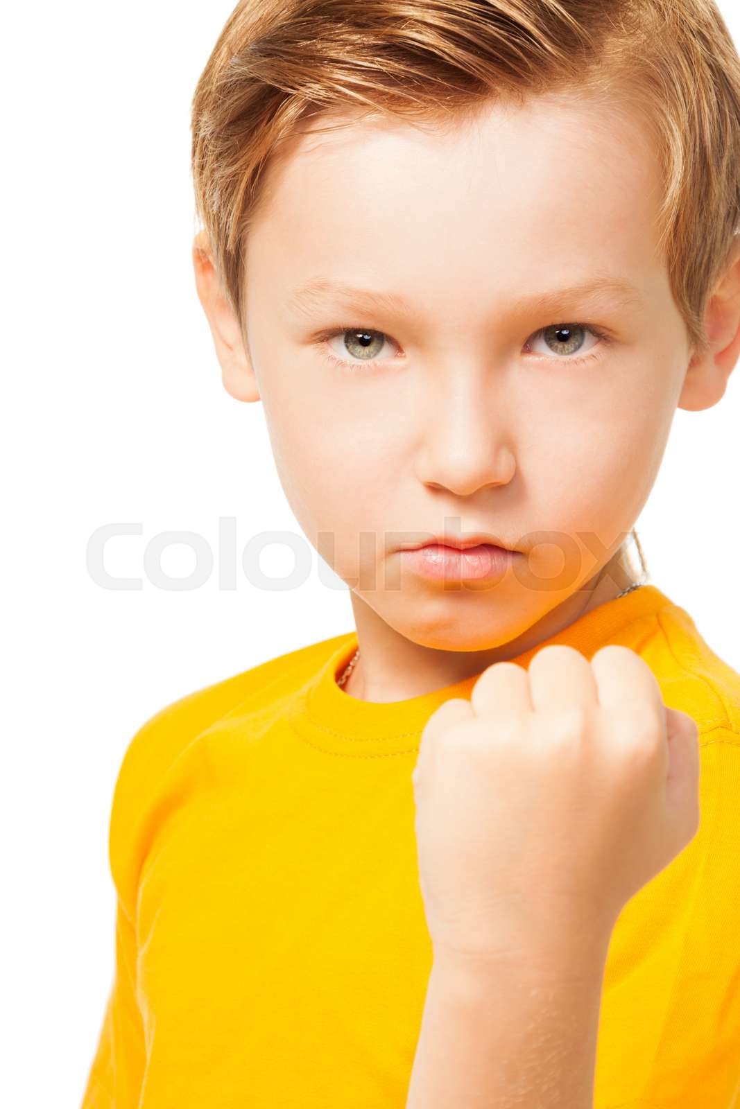 Bad tempered kid showing his fist | Stock image | Colourbox