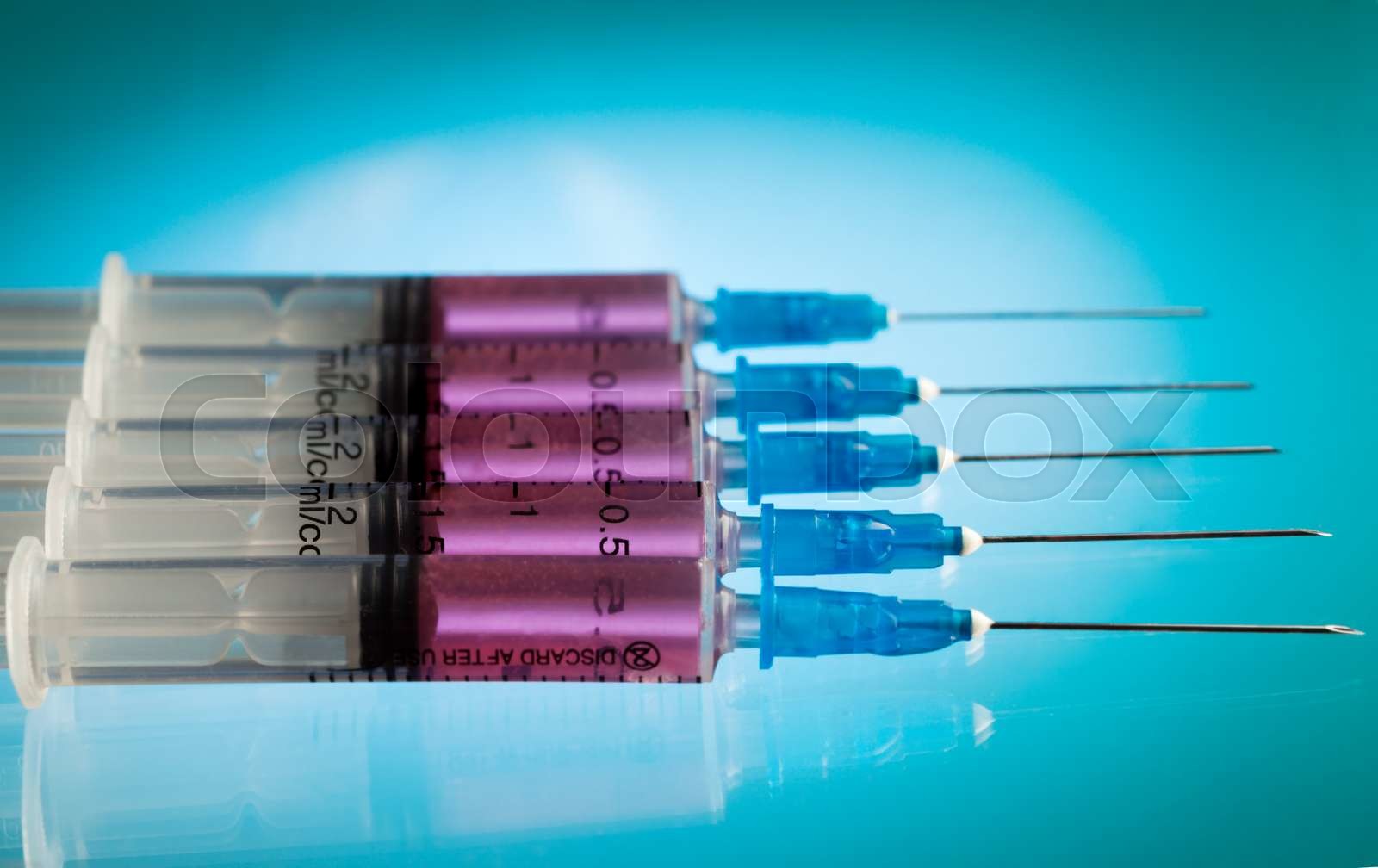 Five syringes with pink medicine | Stock image | Colourbox