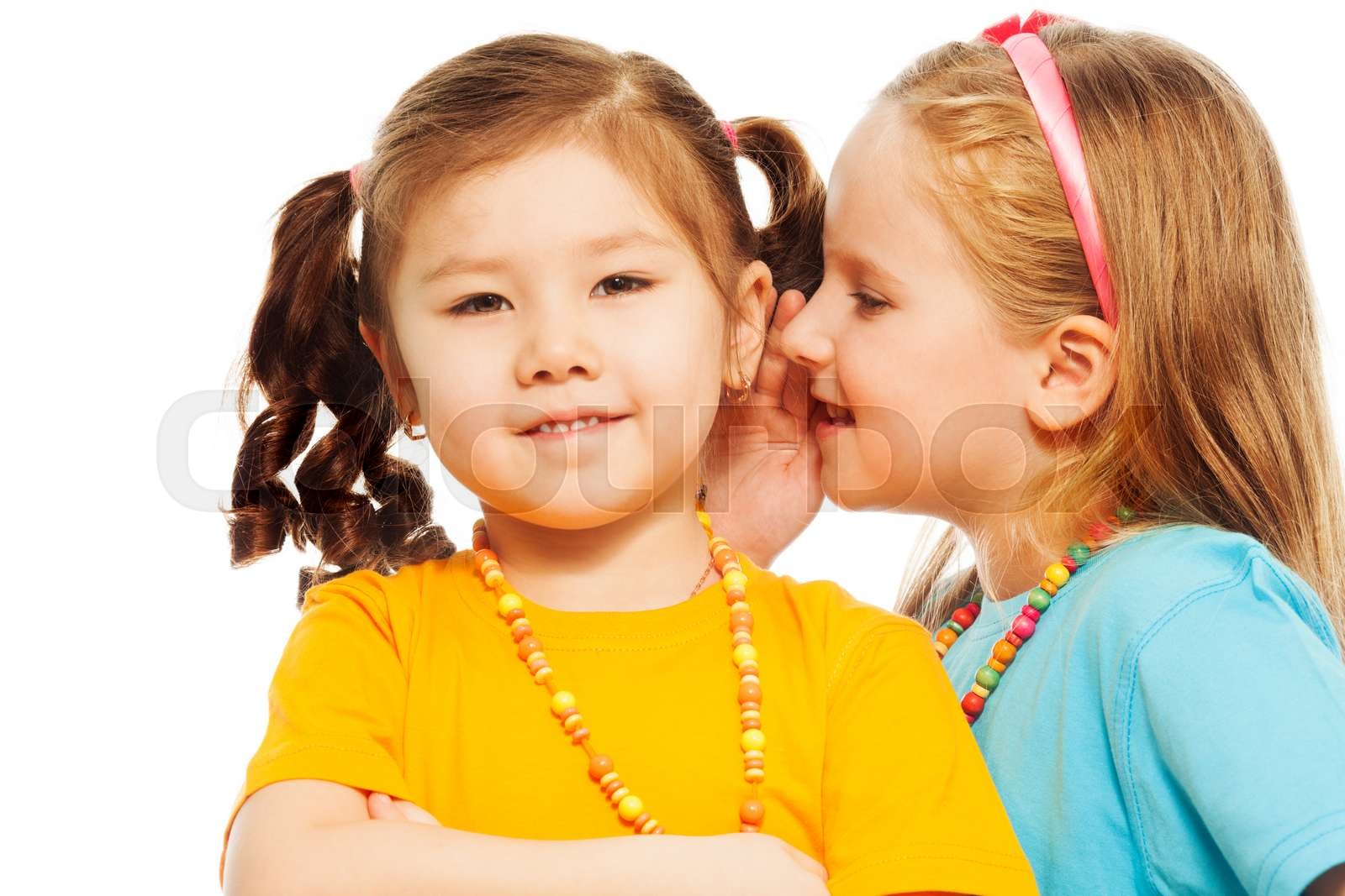 Whisper in friends ear | Stock image | Colourbox