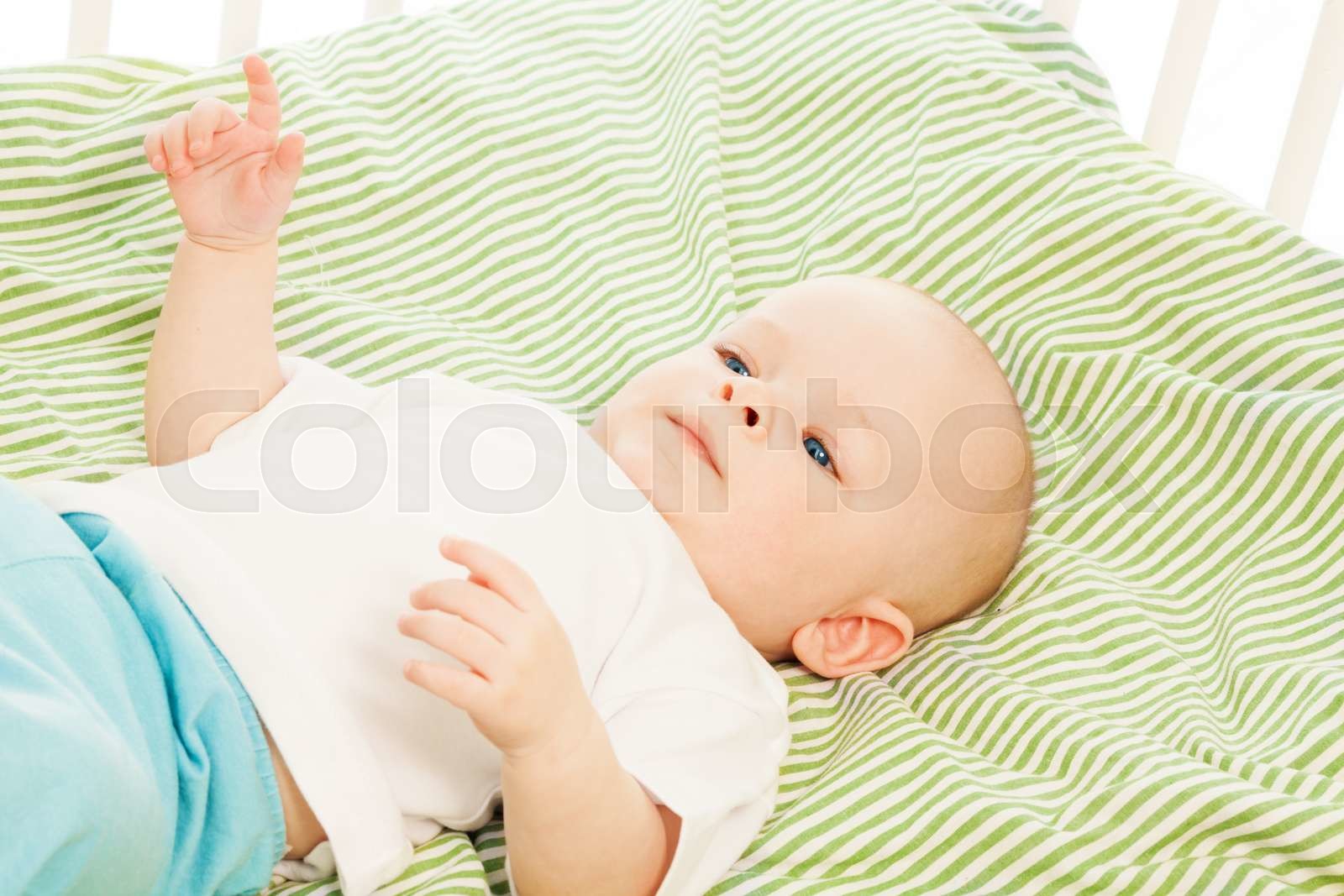 Little boy laying in bed | Stock image | Colourbox