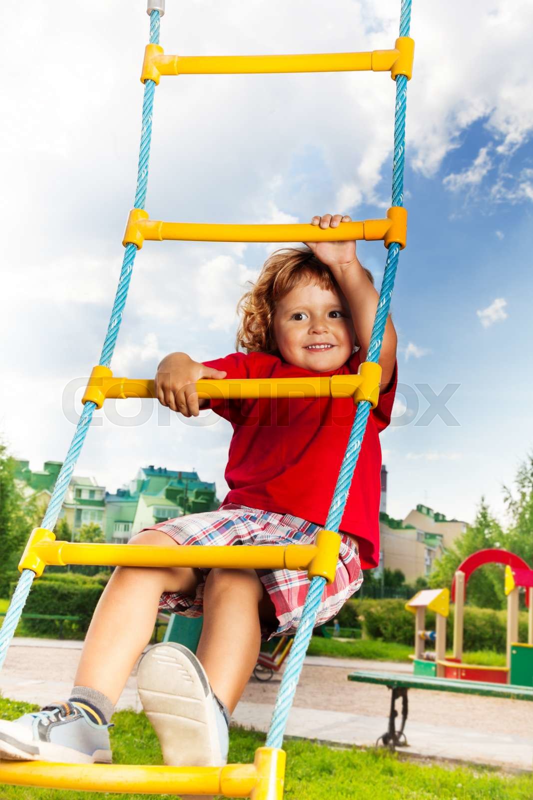 Boy climbing on rope ladder | Stock image | Colourbox