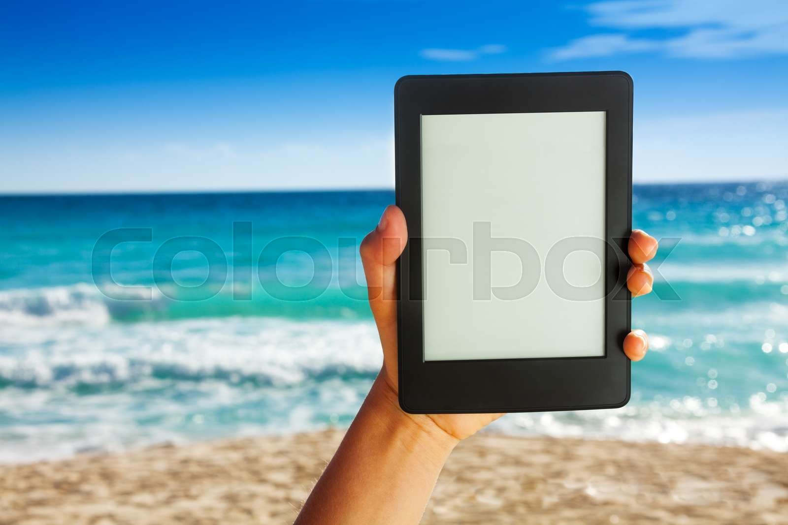 Man hand holding electronic device for reading | Stock image | Colourbox