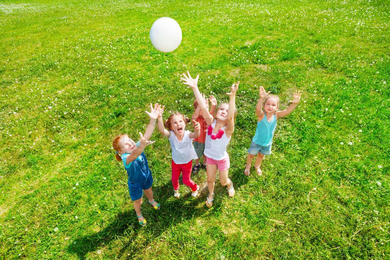 Kids playing ball on a meadow | Stock image | Colourbox