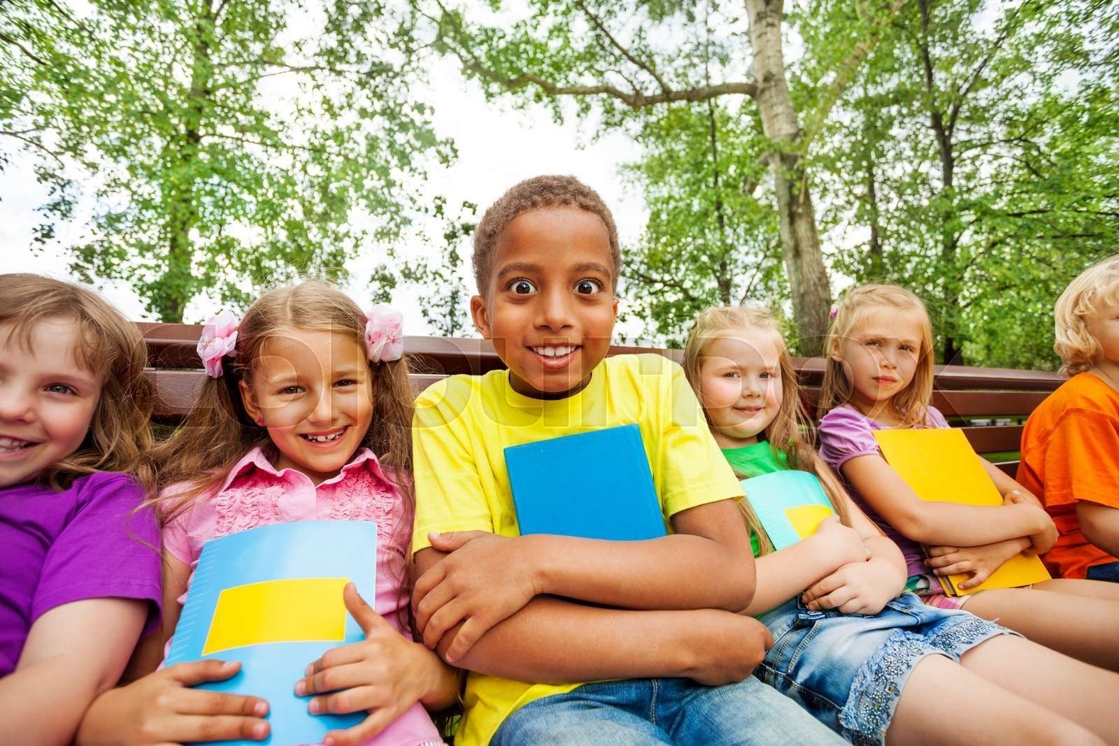 Close up view of school kids having fun on bench | Stock image | Colourbox