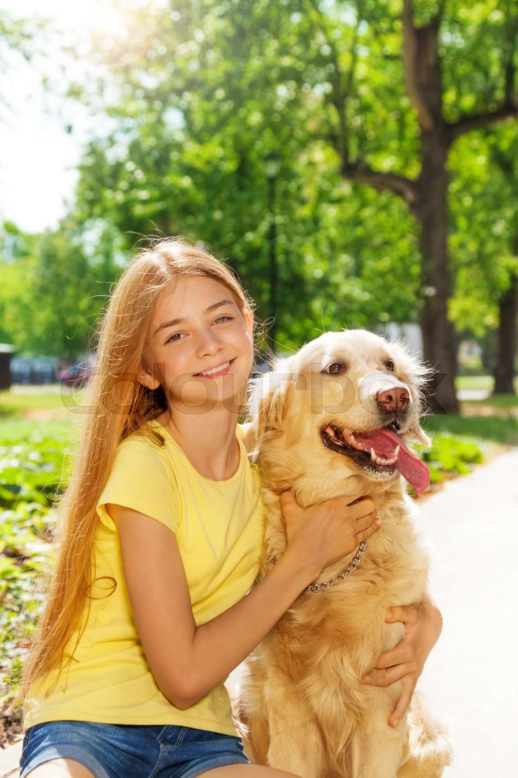 Teenage blonde girl with retriever dog otside | Stock image | Colourbox