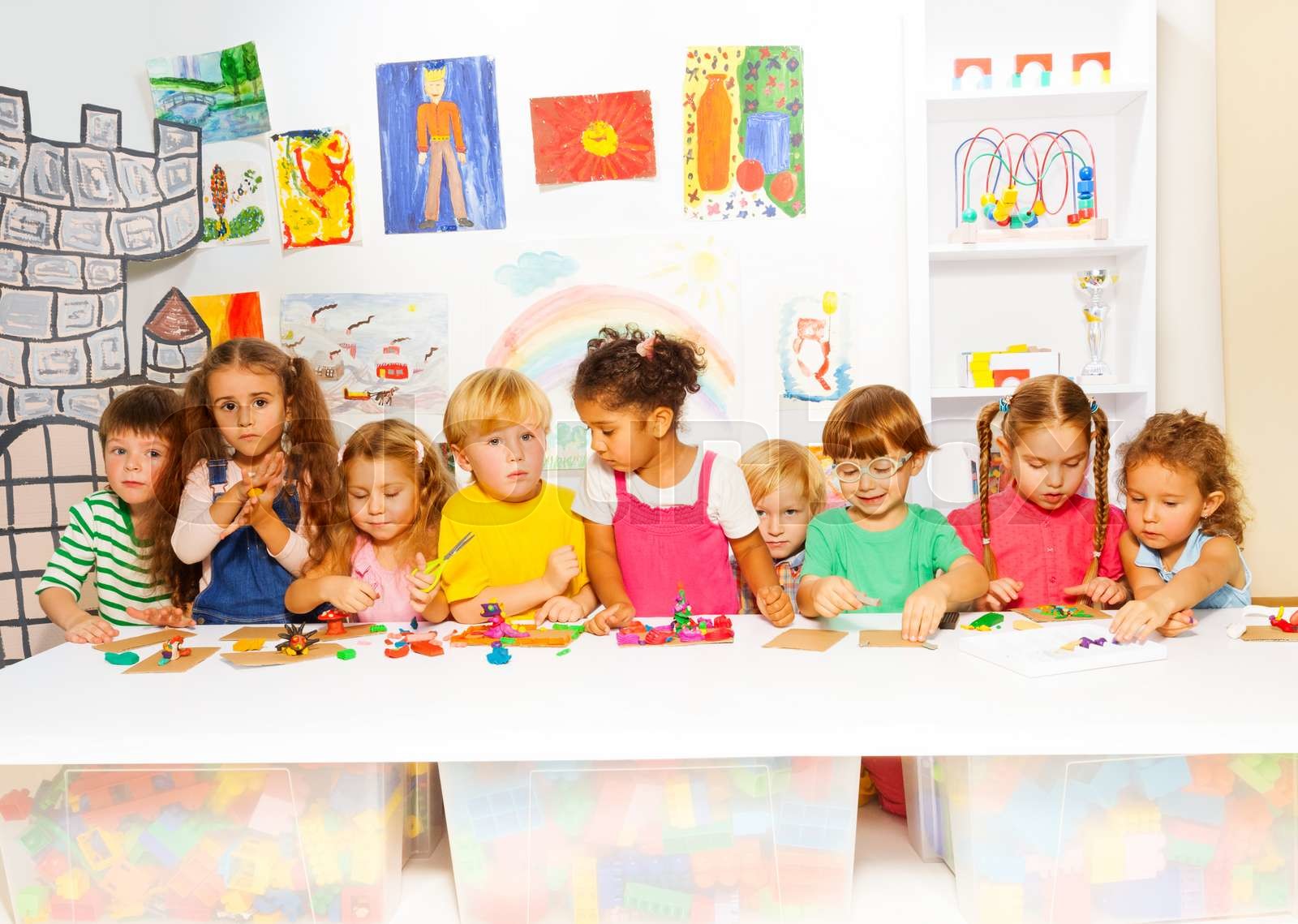 Large group of kids play with plasticine in class | Stock image | Colourbox