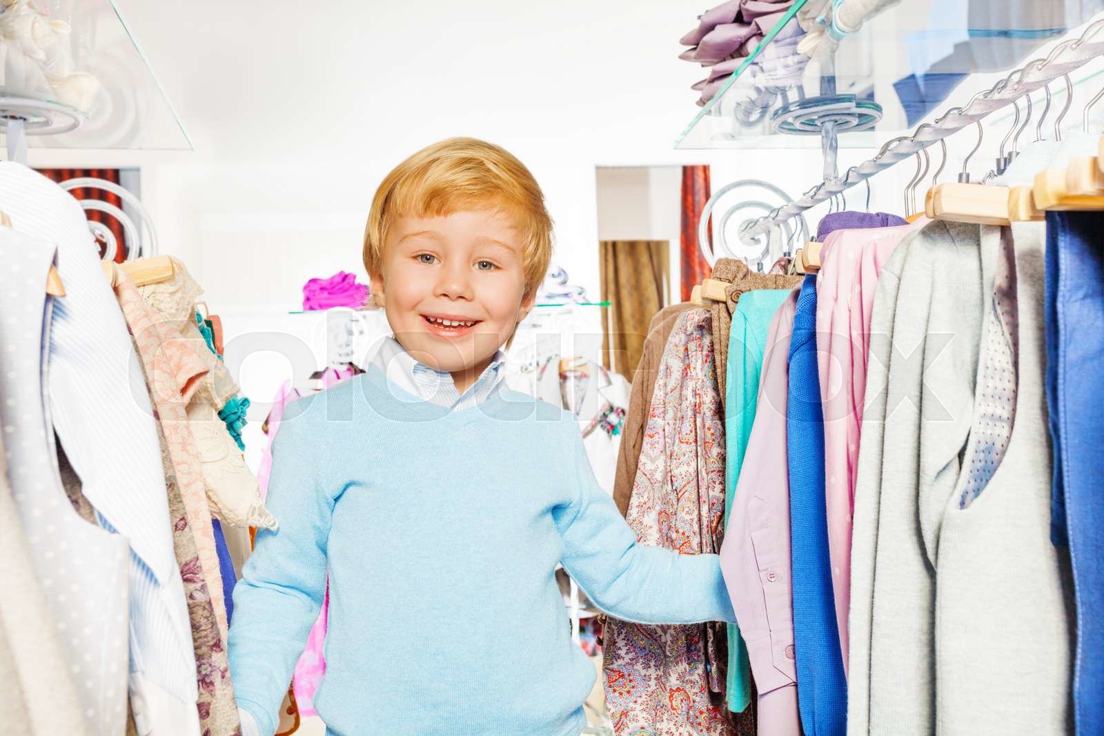 Happy blond boy laughing in shopping mall | Stock image | Colourbox