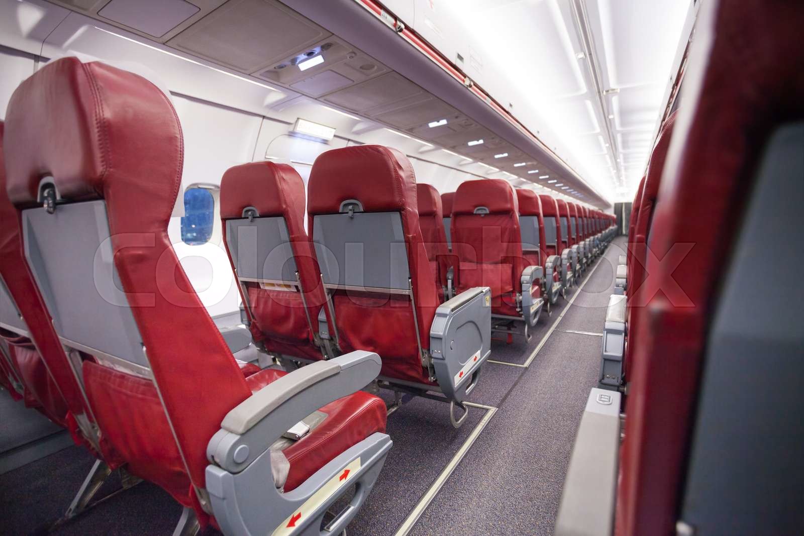 Long aisle with rows of sits in airplane economy | Stock image | Colourbox