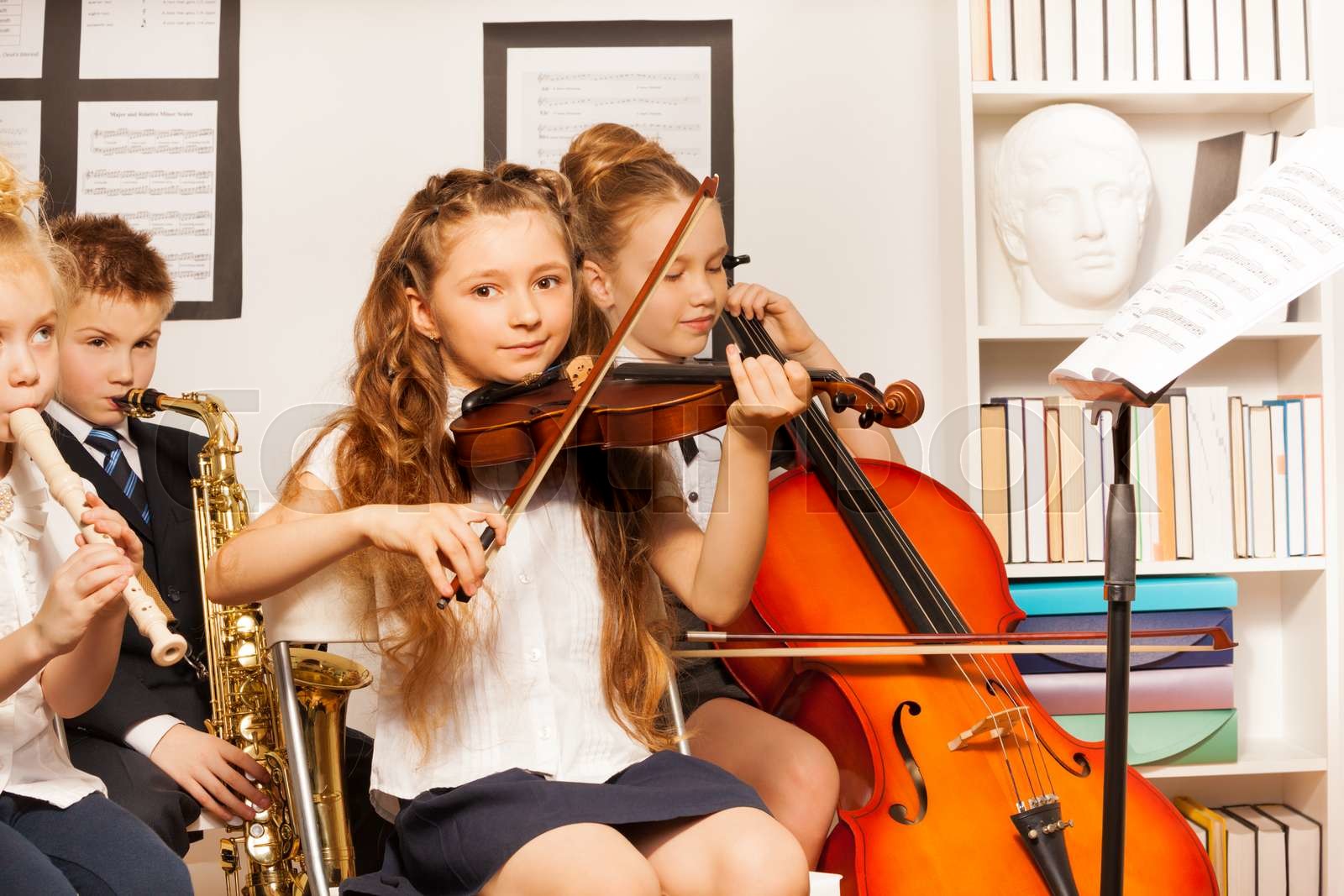 Group of kids playing musical instruments indoors | Stock image | Colourbox