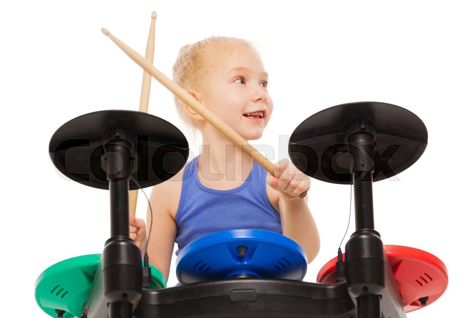 Close-up view of small girl playing on cymbals | Stock image | Colourbox